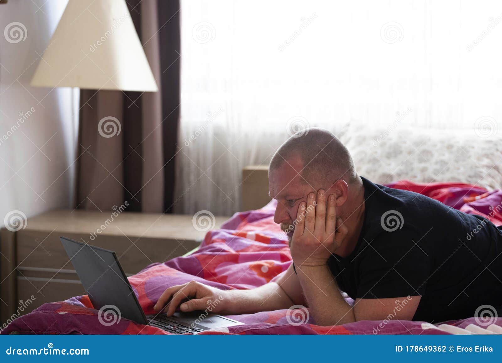 Middle Aged Man Using Laptop while Lying in Bed Stock Photo - Image of ...