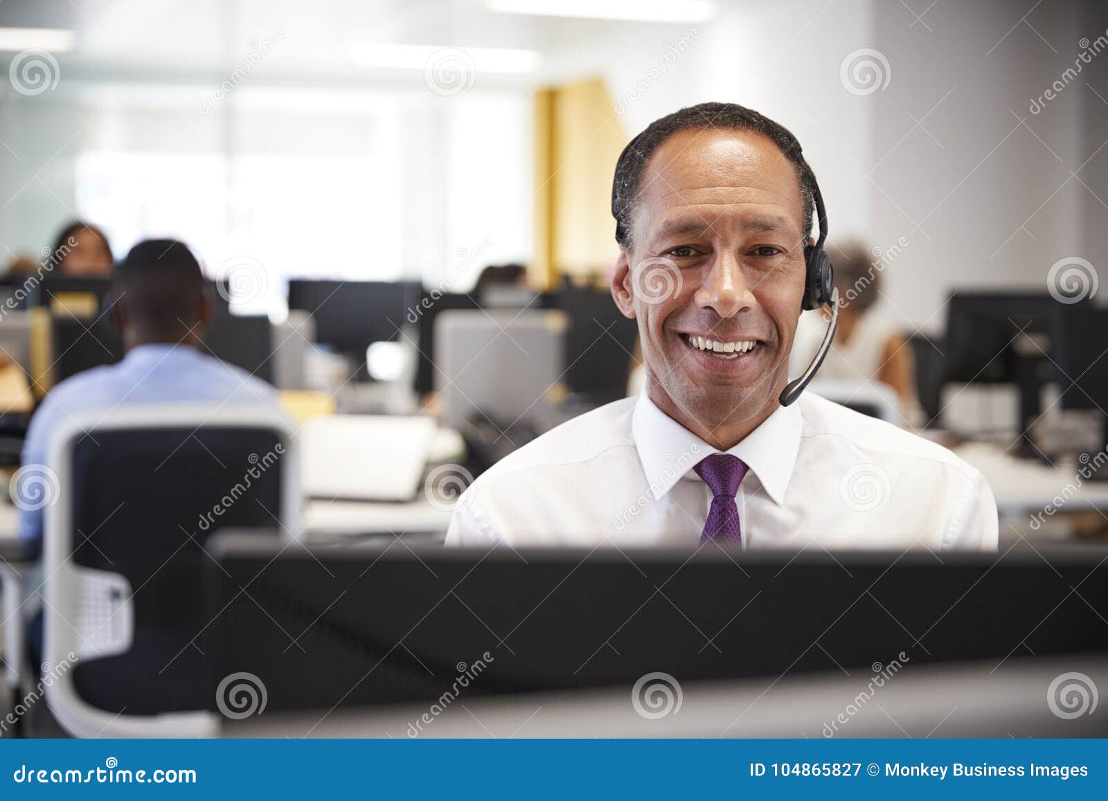 Middle Aged Man Working at Computer with Headset in Office Stock Image ...