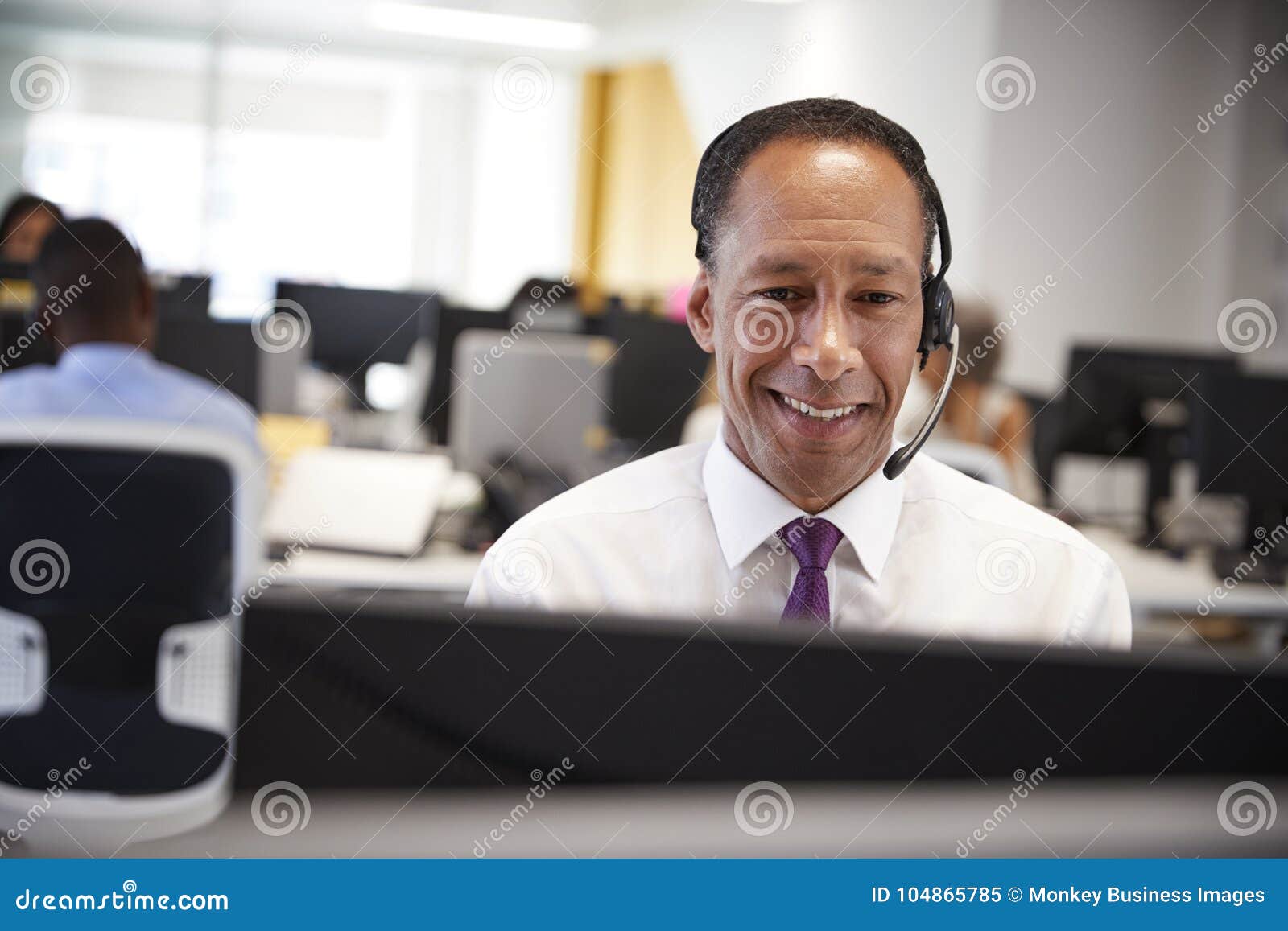 Middle Aged Man Working at Computer with Headset in Office Stock Image ...