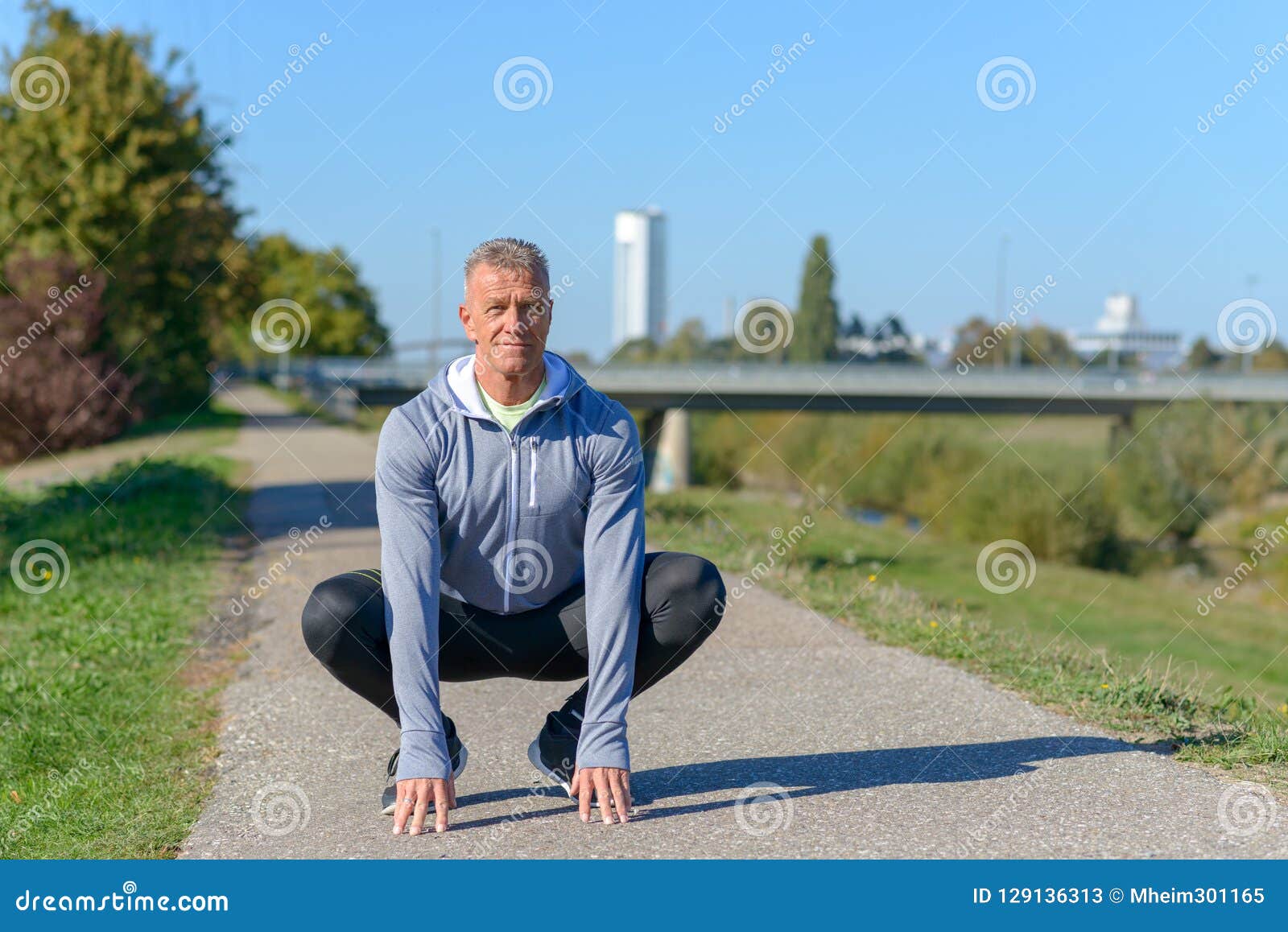 Middle Aged Runner Sitting in a Squat Stock Image - Image of sport ...