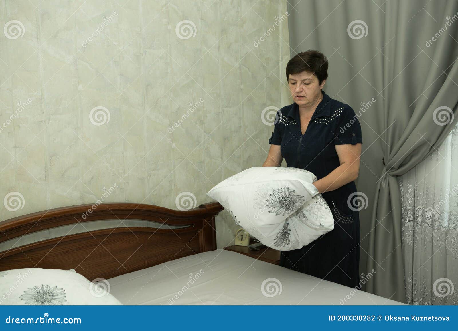 Homework. a Middle-aged Woman Covers Fresh Bedding Stock Photo - Image ...