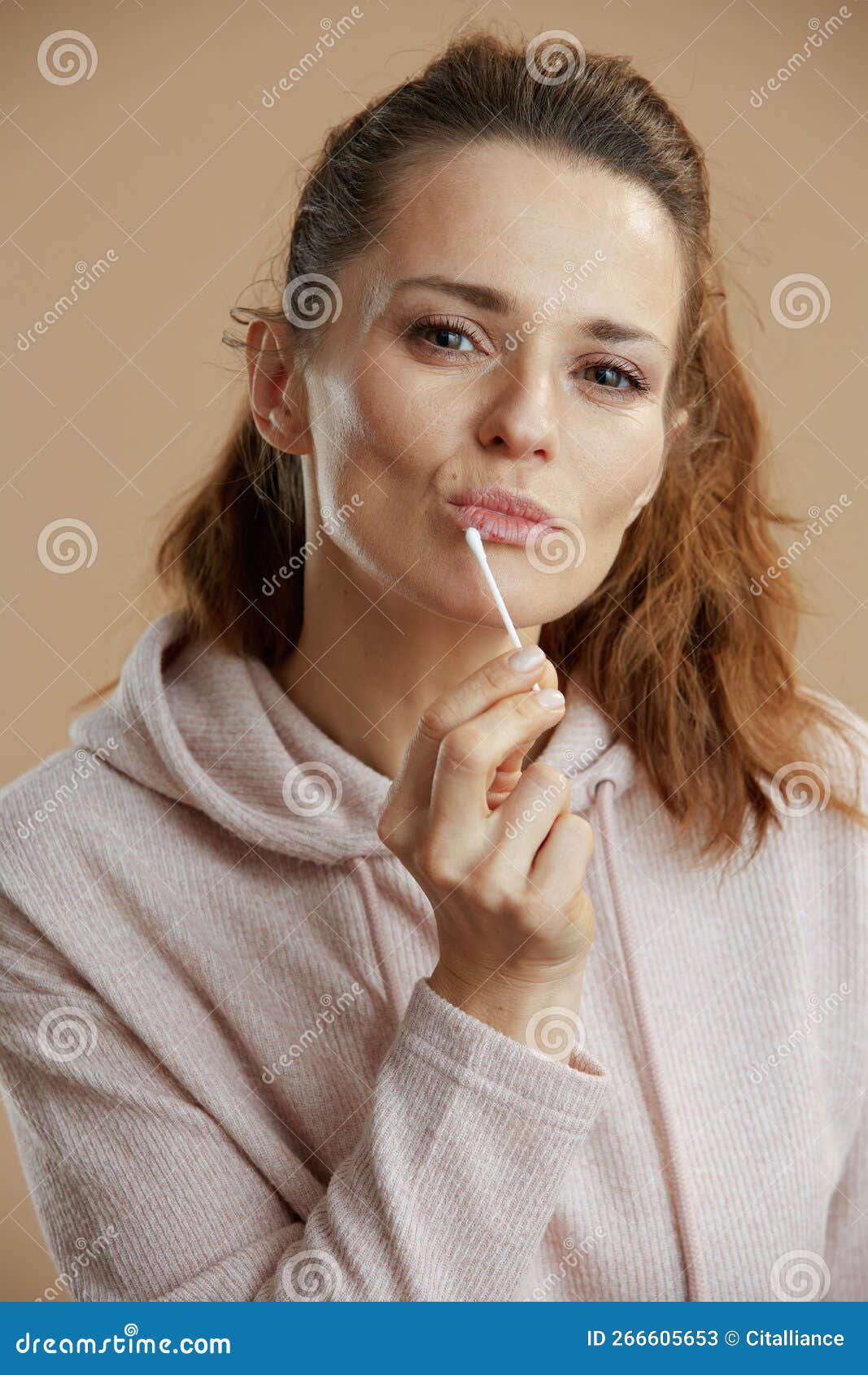 Woman Applying Ointment Using Cotton Swab Against Beige Stock Image Image Of Generation Model