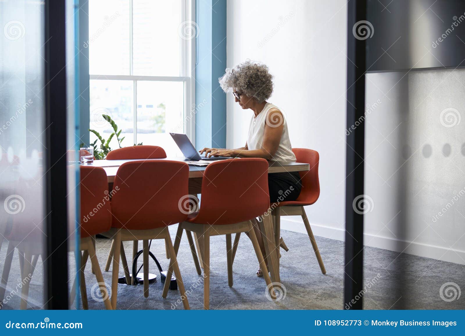 Middle Aged Woman Working Alone in Office Boardroom Stock Image - Image ...