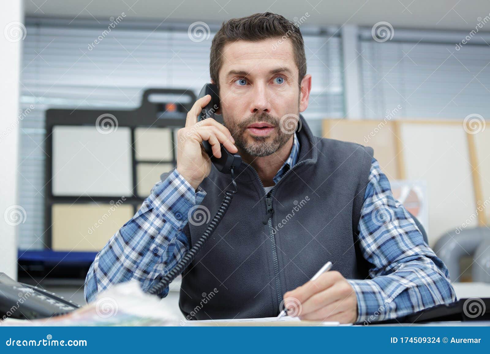 Middle Aged Worker Working on Phone in Workshop Stock Photo - Image of ...