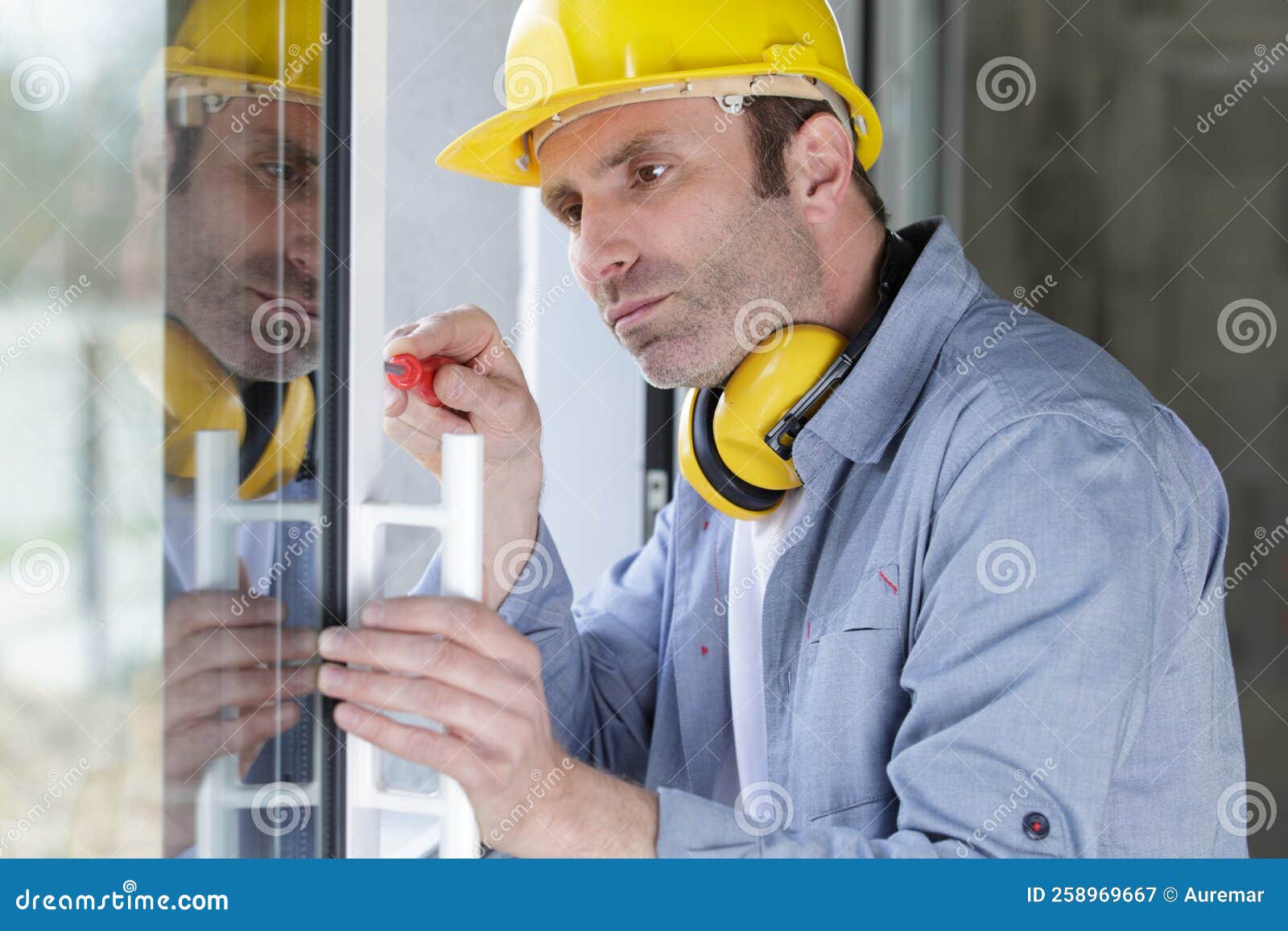 Middle-aged Workman Using Screwdriver on Door Stock Image - Image of ...