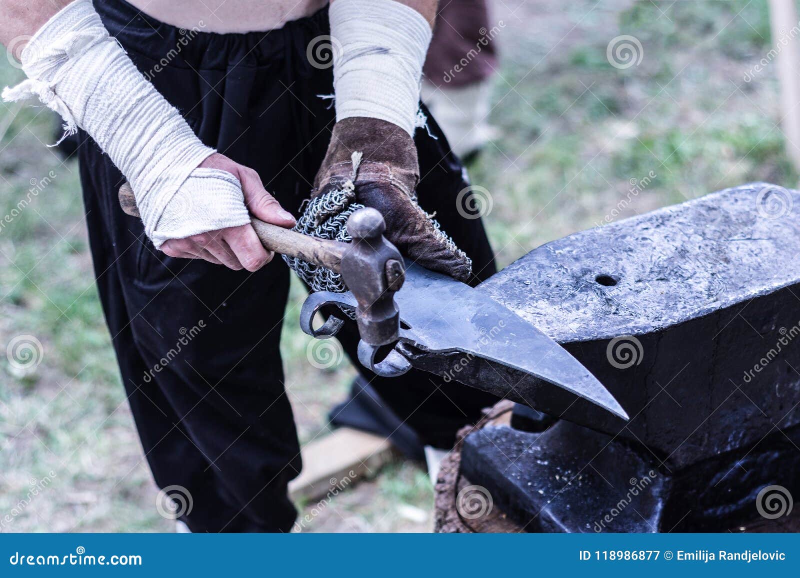 Medieval Blacksmith Crafting an Axe on Anvil with Hammer in Nature ...