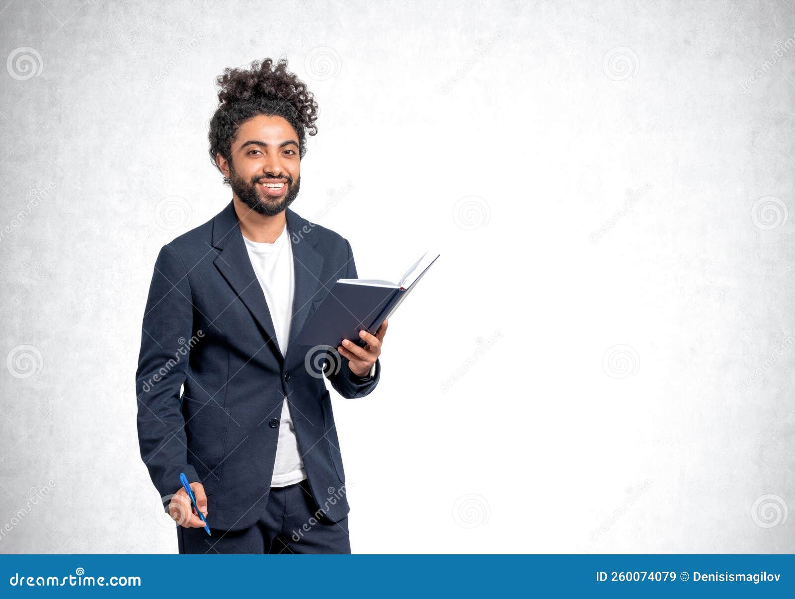 Middle Eastern Businessman with Notebook and Pen Smiling, Copy S Stock ...