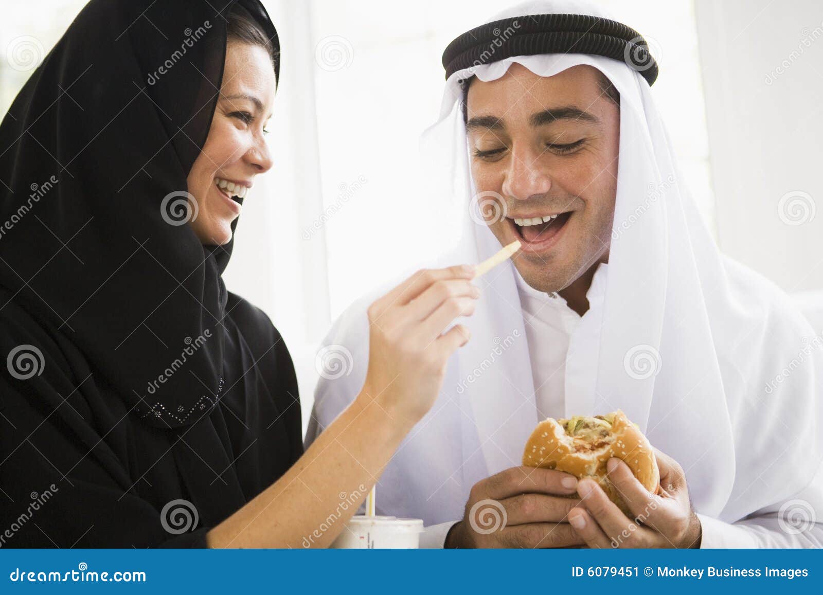 A Middle Eastern Couple Sharing a Fast Food Meal Stock Image - Image of ...