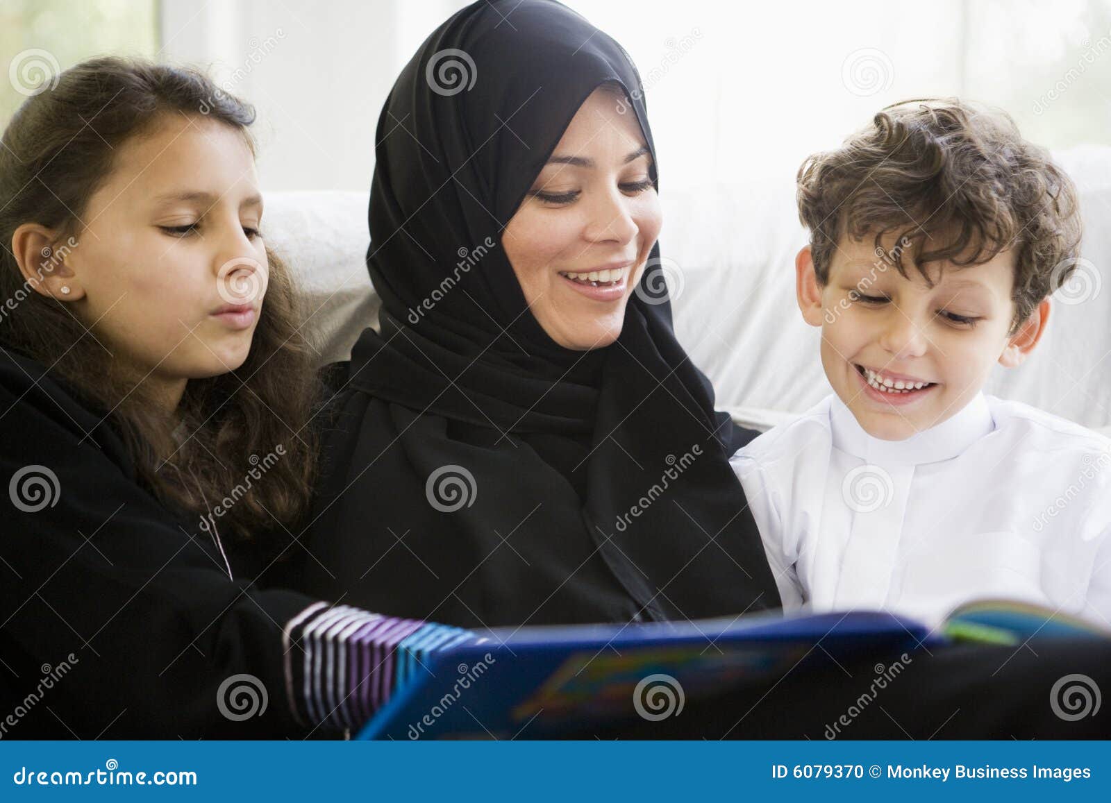 A Middle Eastern Family Reading a Book Together Stock Photo - Image of ...