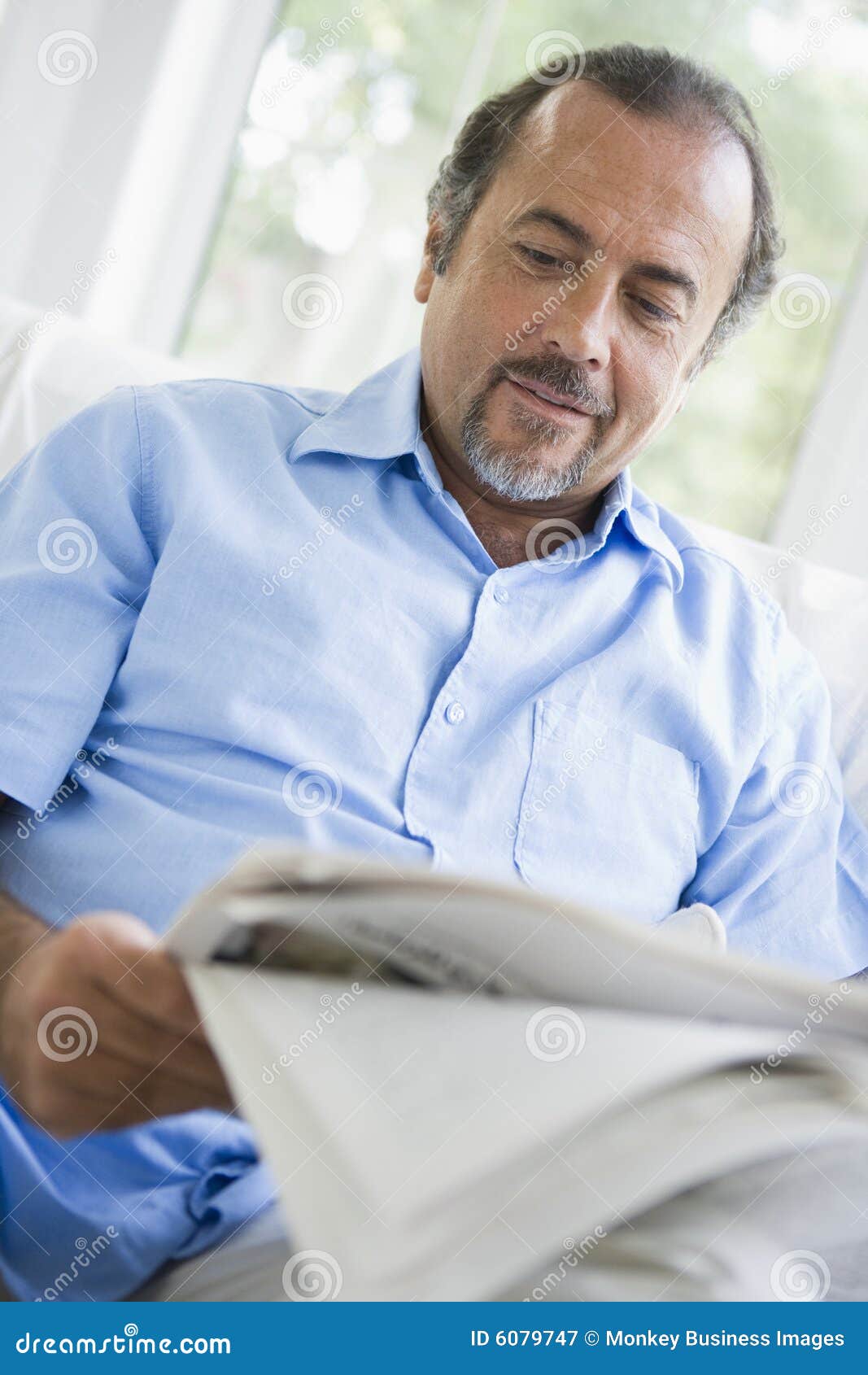 A Middle Eastern Man Reading a Newspaper at Home Stock Image - Image of ...