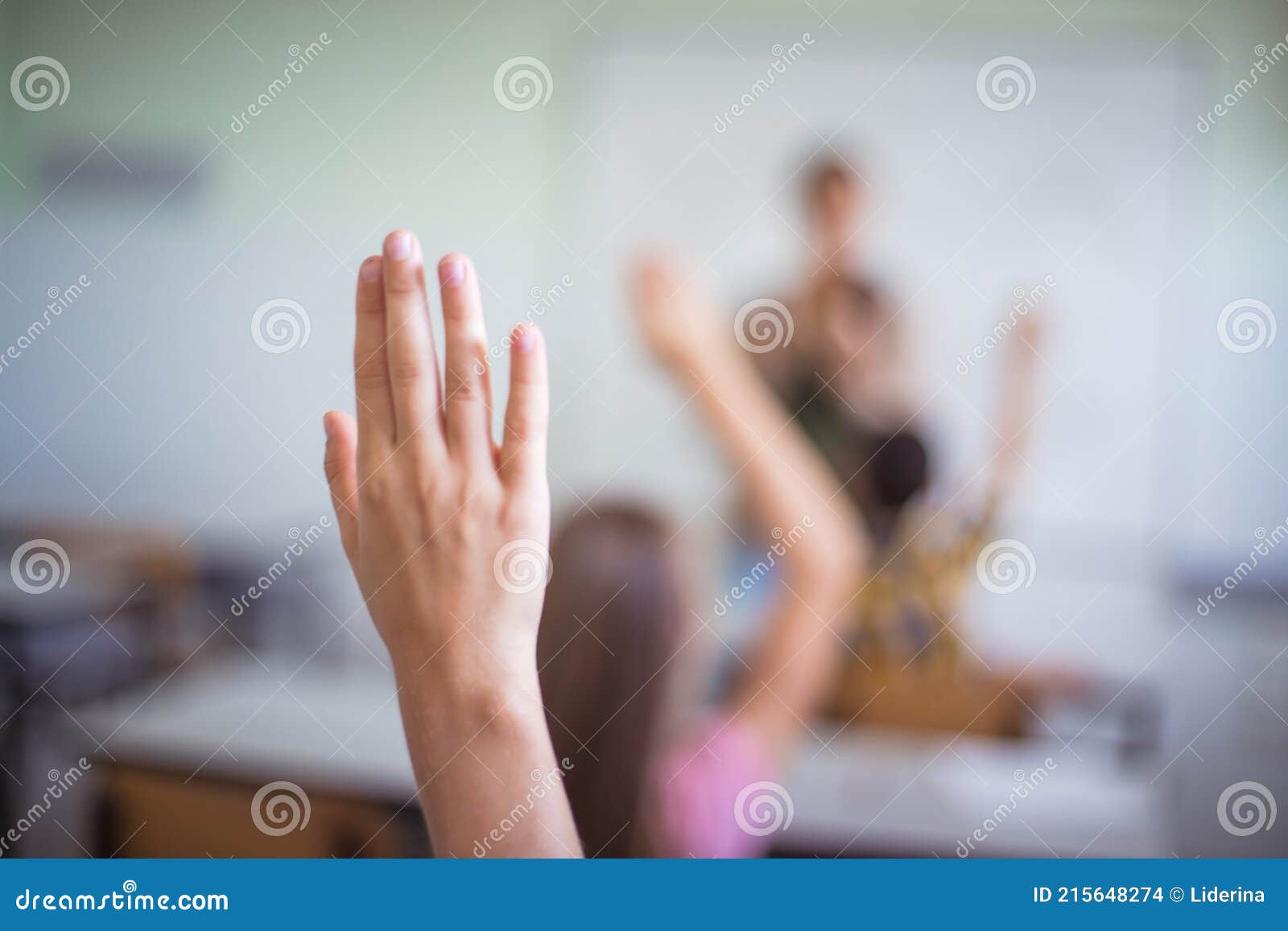 Middle Group of Students Raising Their Arms To Answer the Question ...