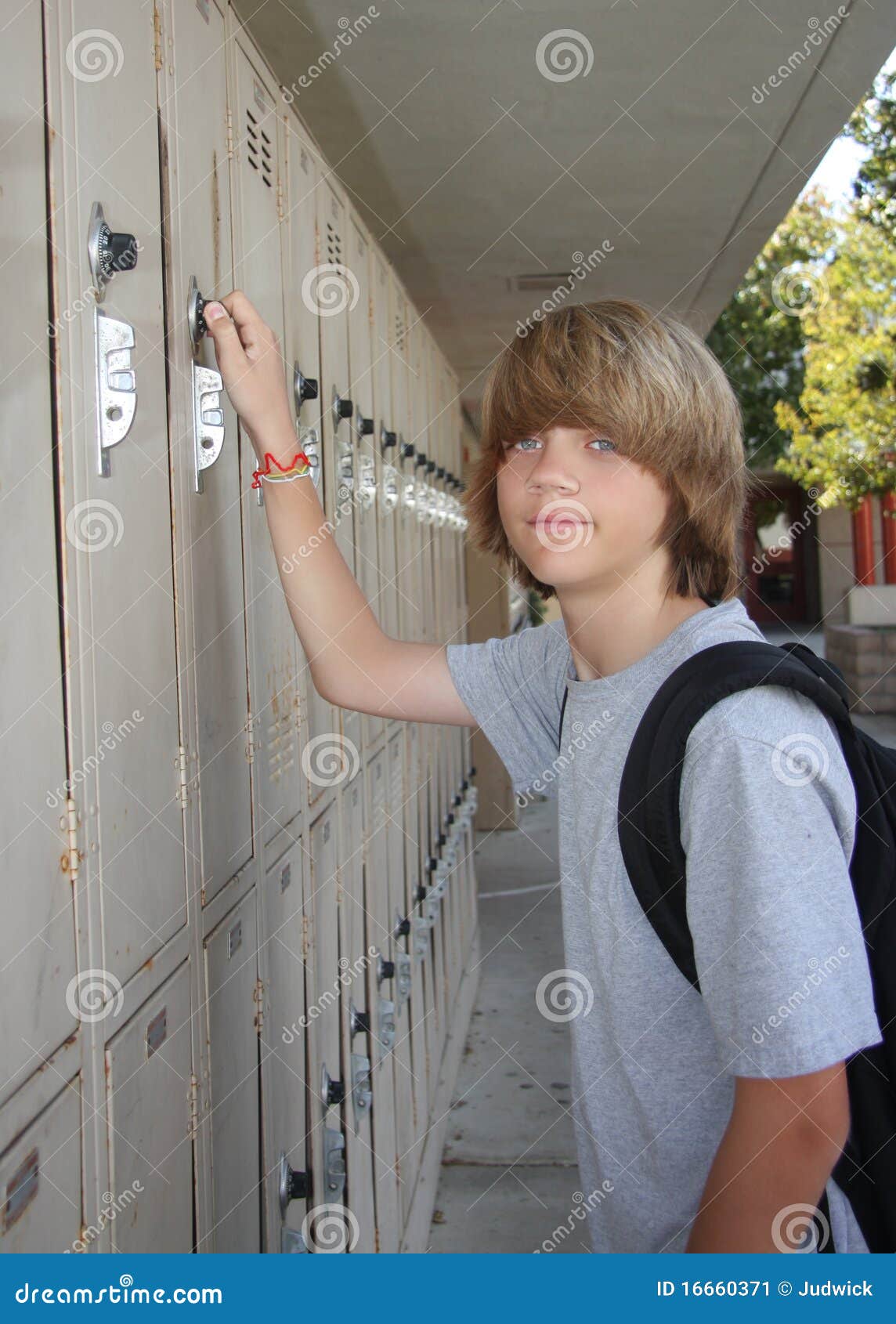Middle schooler at locker stock image. Image of education - 16660371