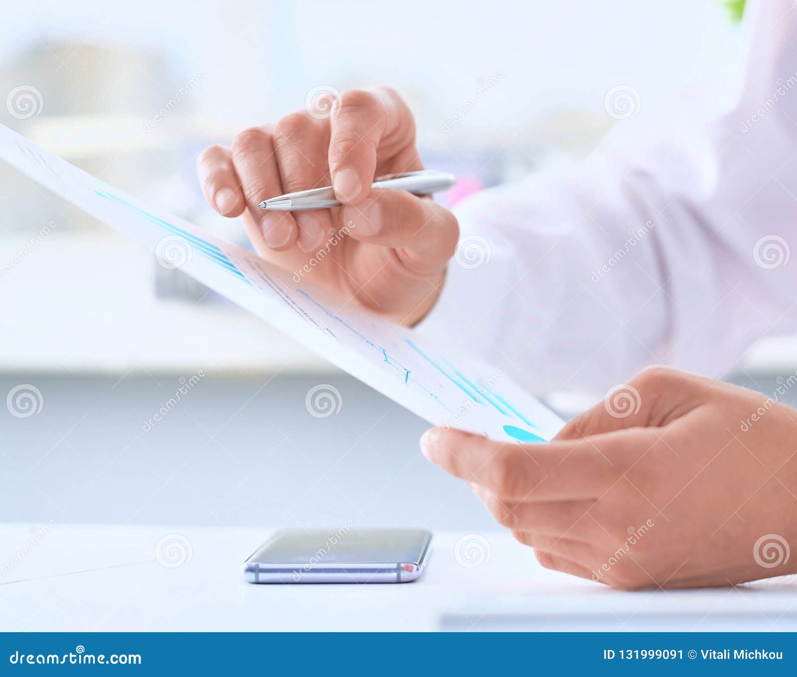 Serious Business Man Working on Documents and Makes Notes with a Stock ...