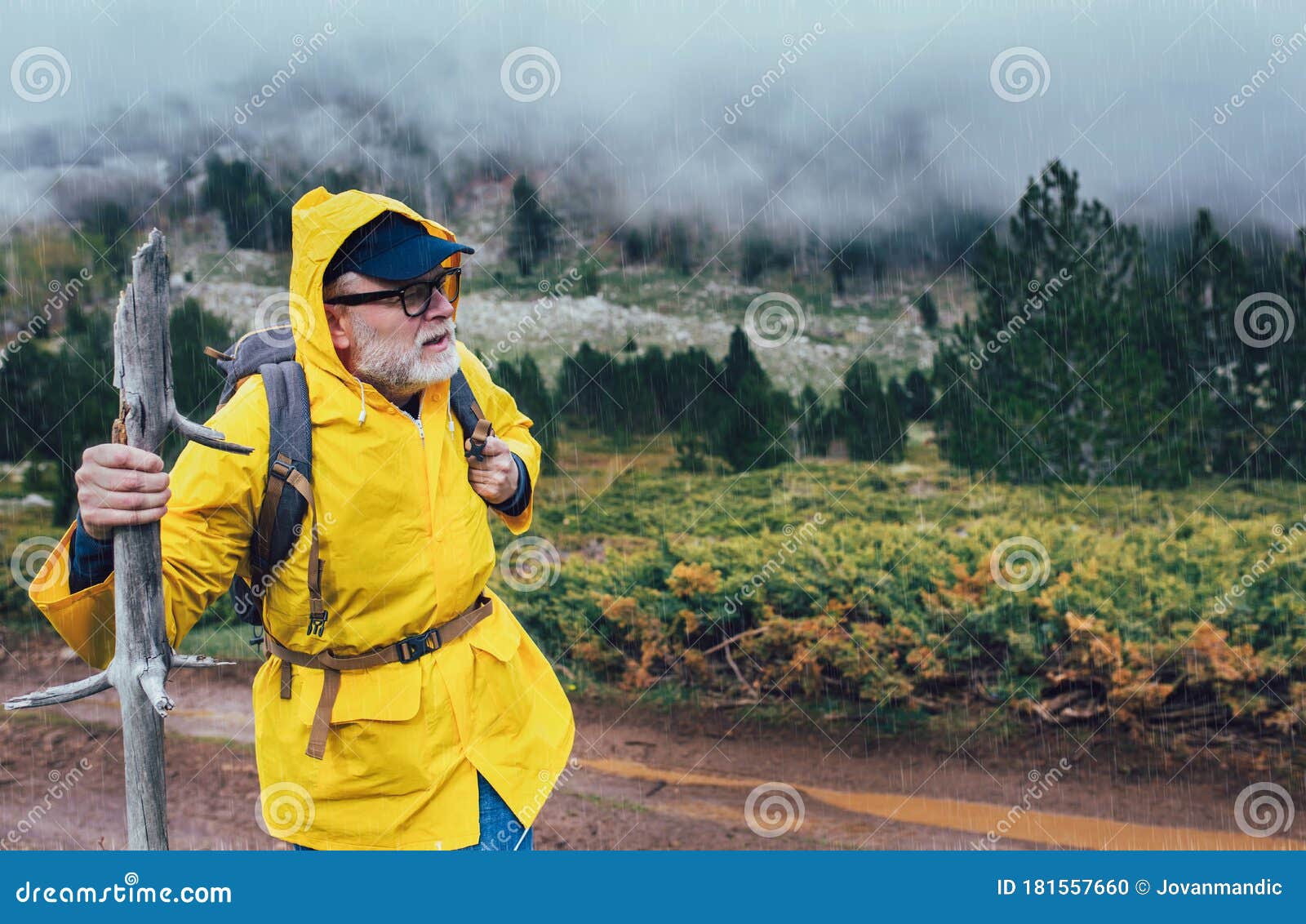 Man in Raincoat and Backpack on Rainy Day in Mountains Stock Photo ...