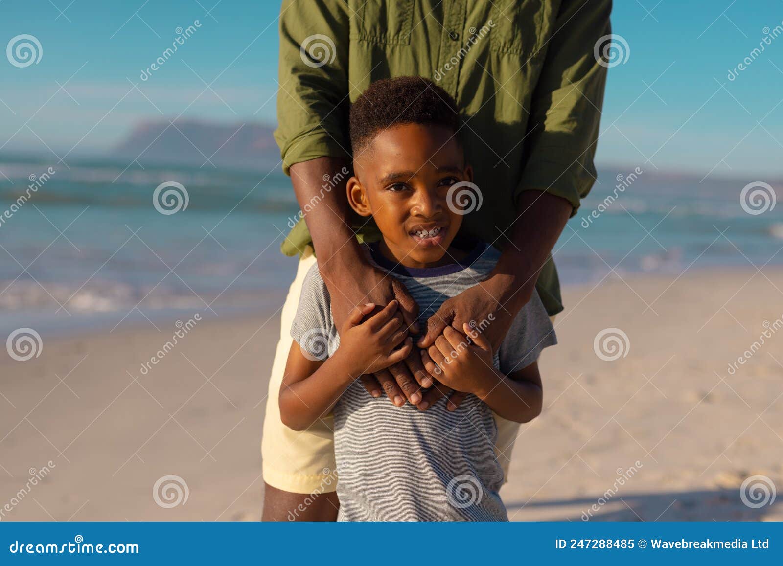 Midsection Of African American Young Man Holding Son S Hands While
