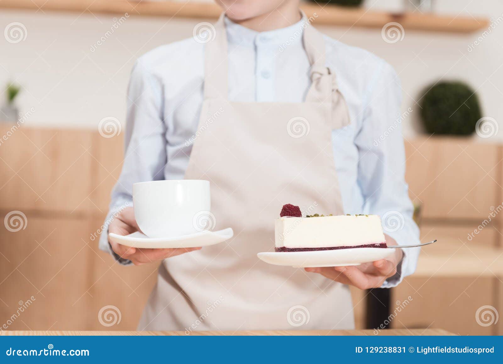 Midsection of Boy in Dickey Holding Cup and Dessert in Hands Stock ...