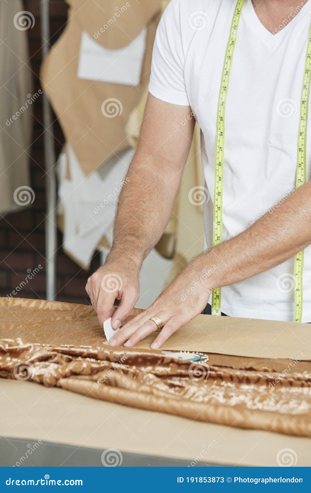 Midsection of Male Tailor Marking Pattern with Chalk on Fabric Stock ...