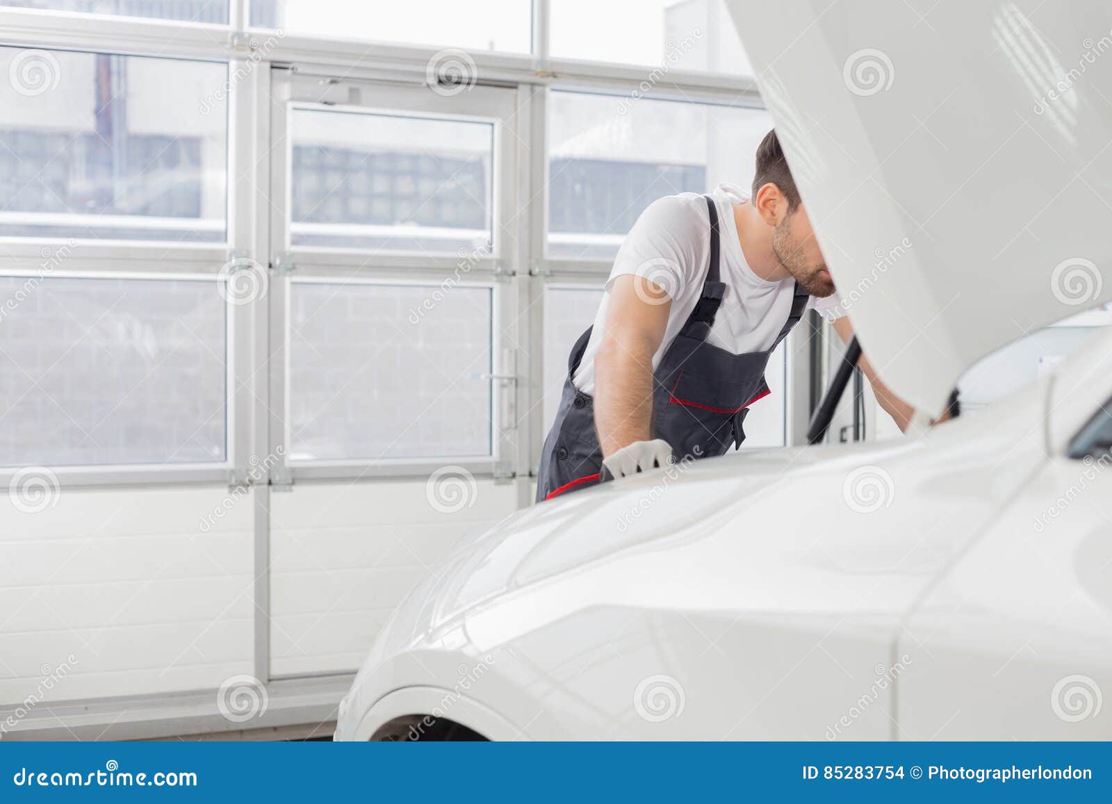 Midsection of Male Technician Repairing Car Engine in Workshop Stock ...