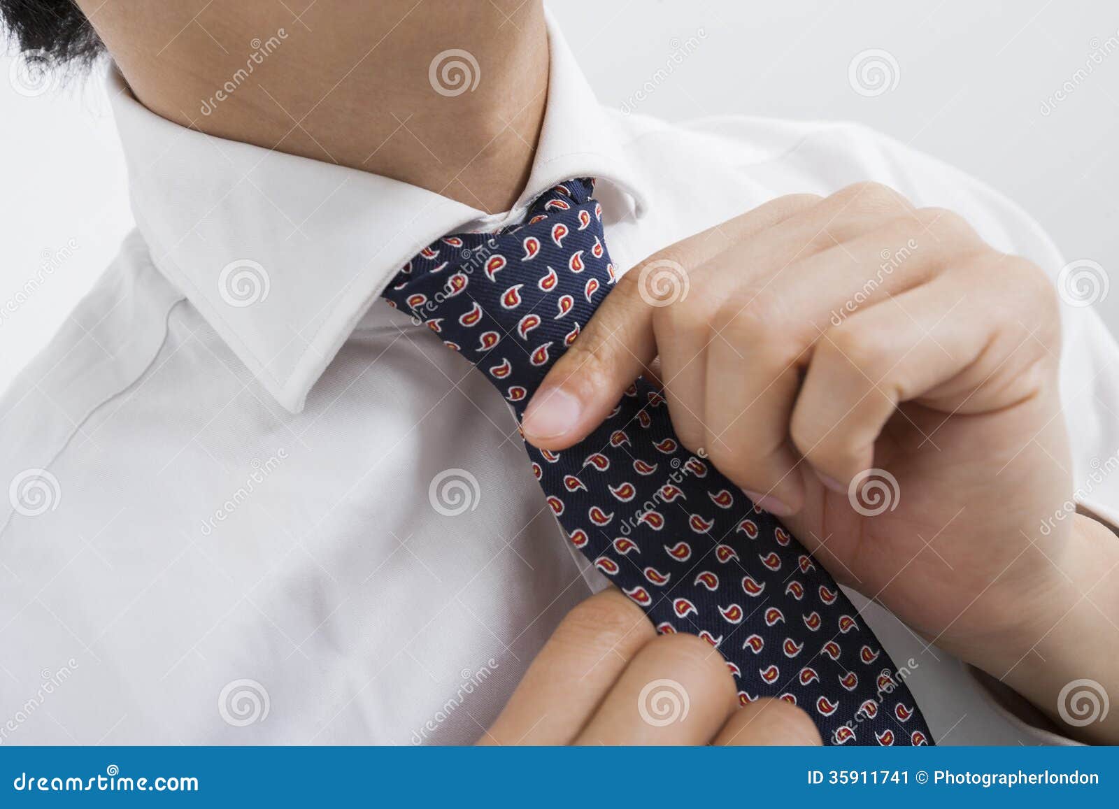 Midsection of Mid Adult Businessman Adjusting Tie Stock Image - Image ...