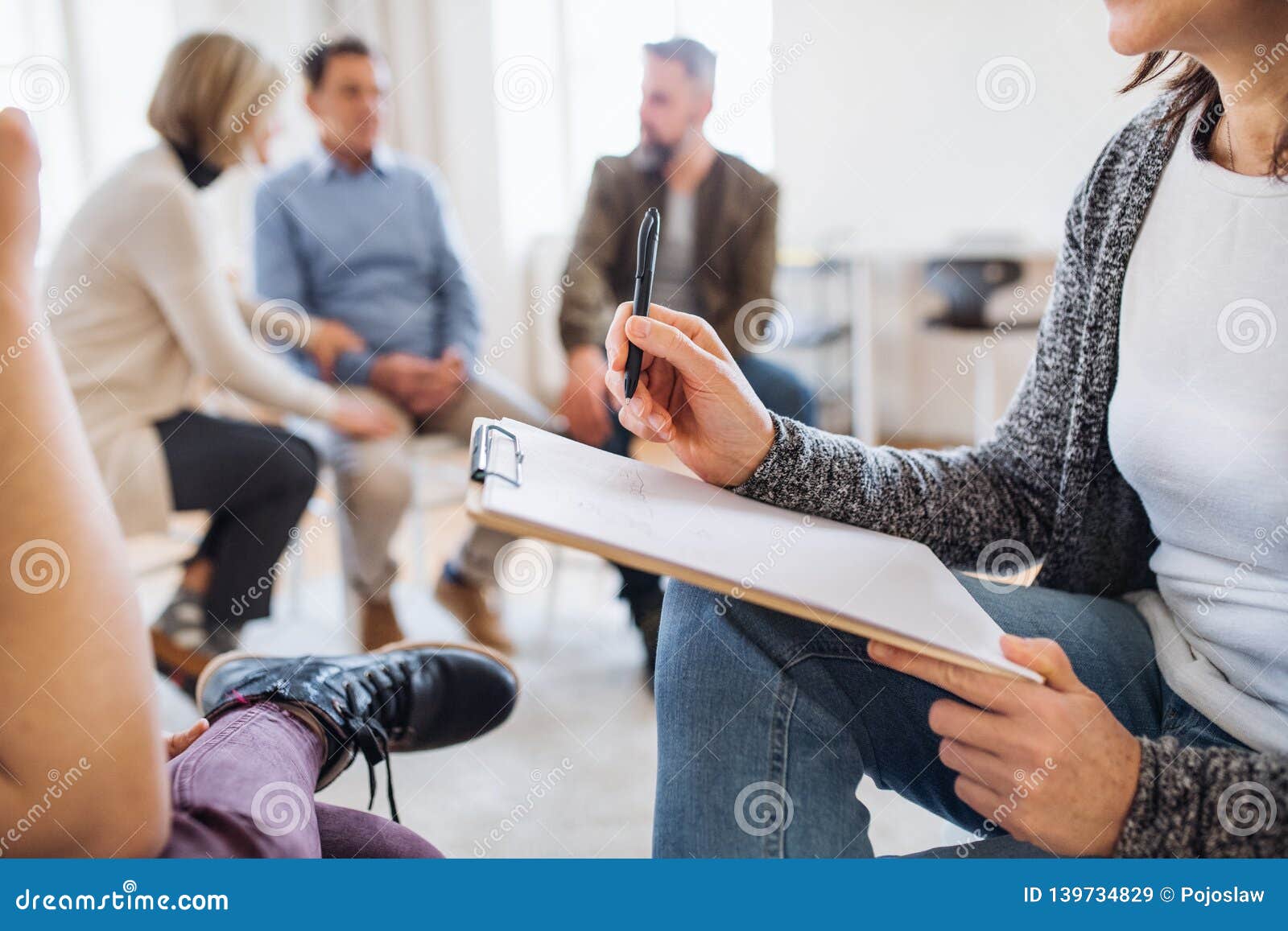 A Midsection of Counselor with Clipboard Talking To a Client during ...