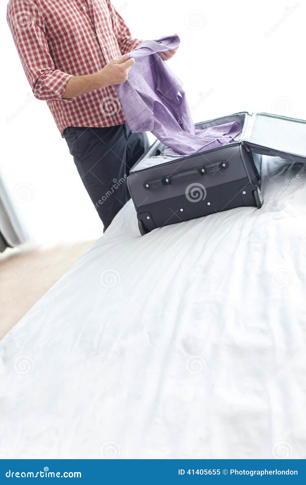 Midsection of Young Businessman Unpacking Suitcase in Hotel Room Stock ...