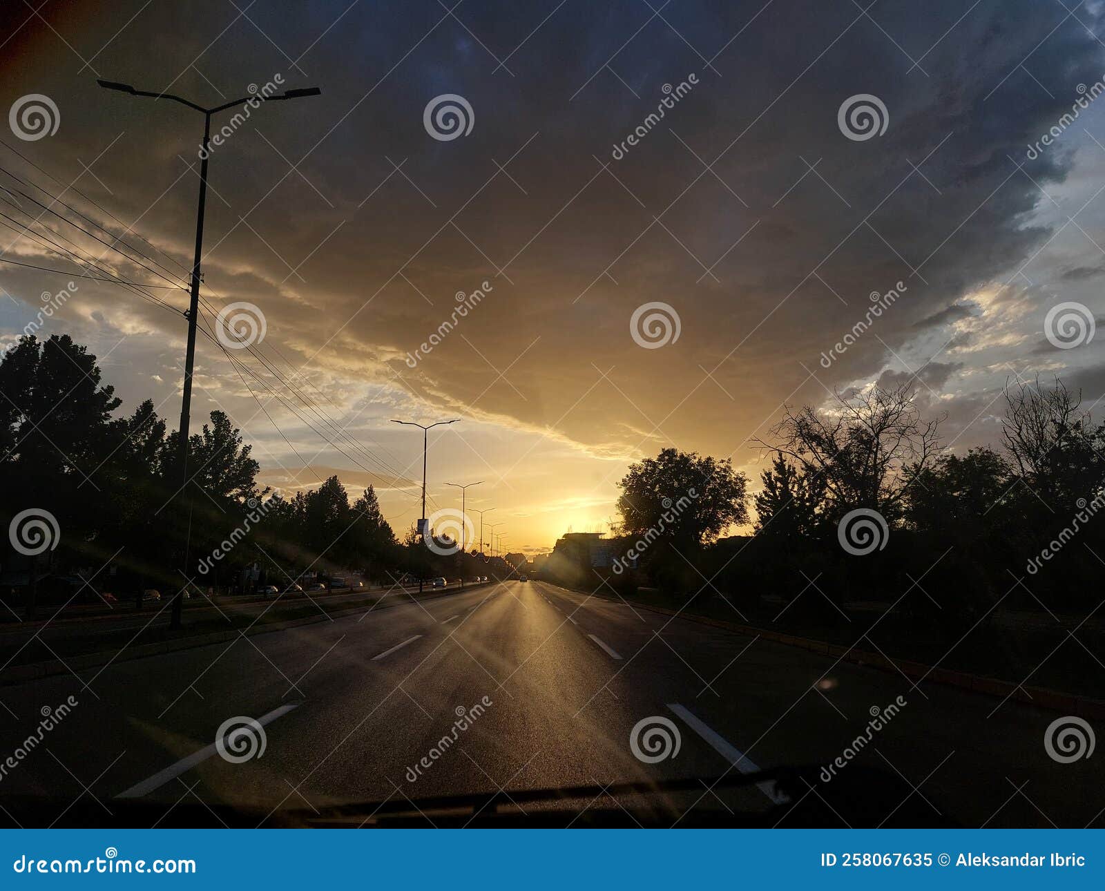 Midsummer Sunset from the Car with a View of the Road during a City ...