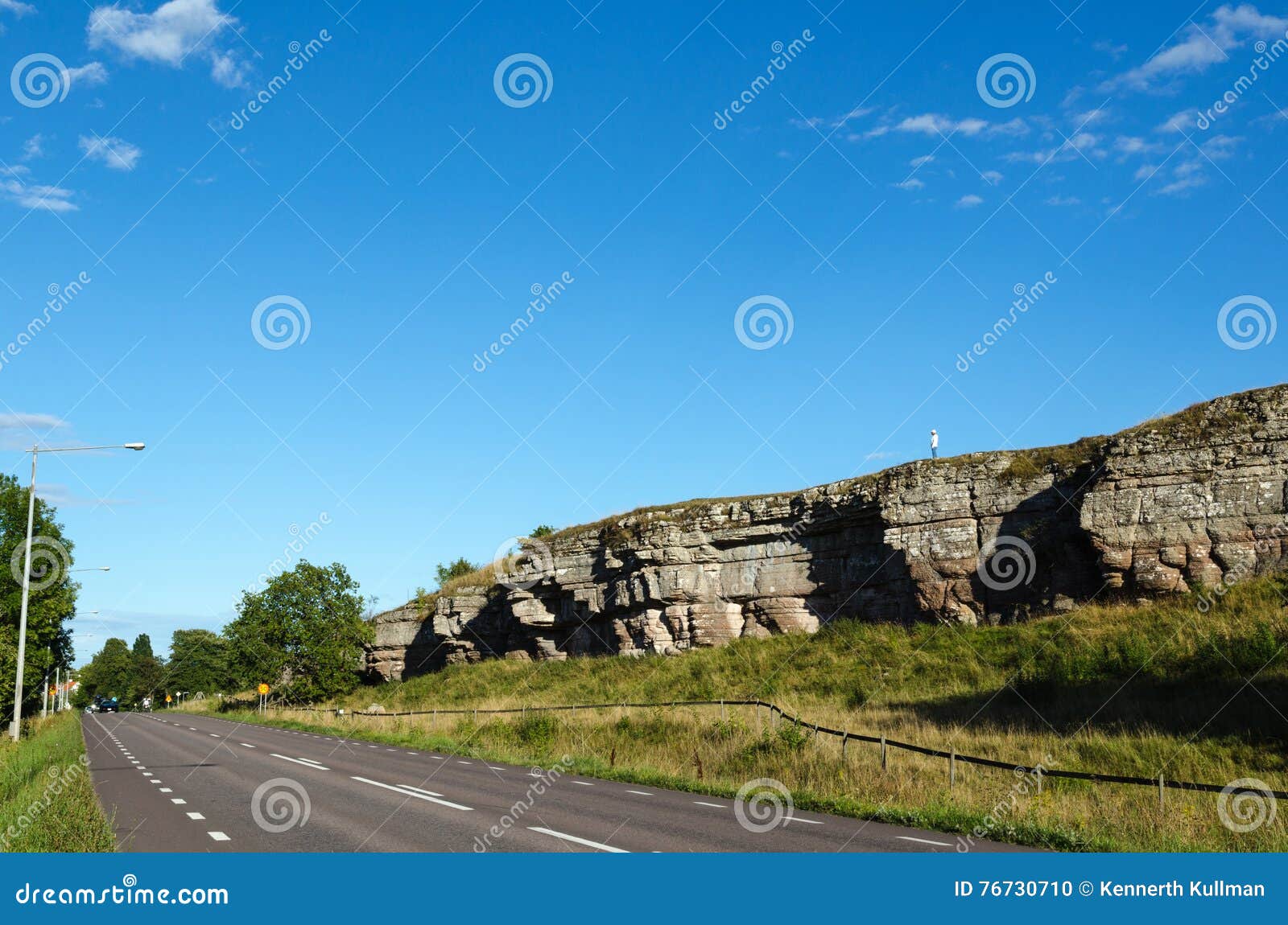 Mighty cliff by roadside stock photo. Image of sunny - 76730710