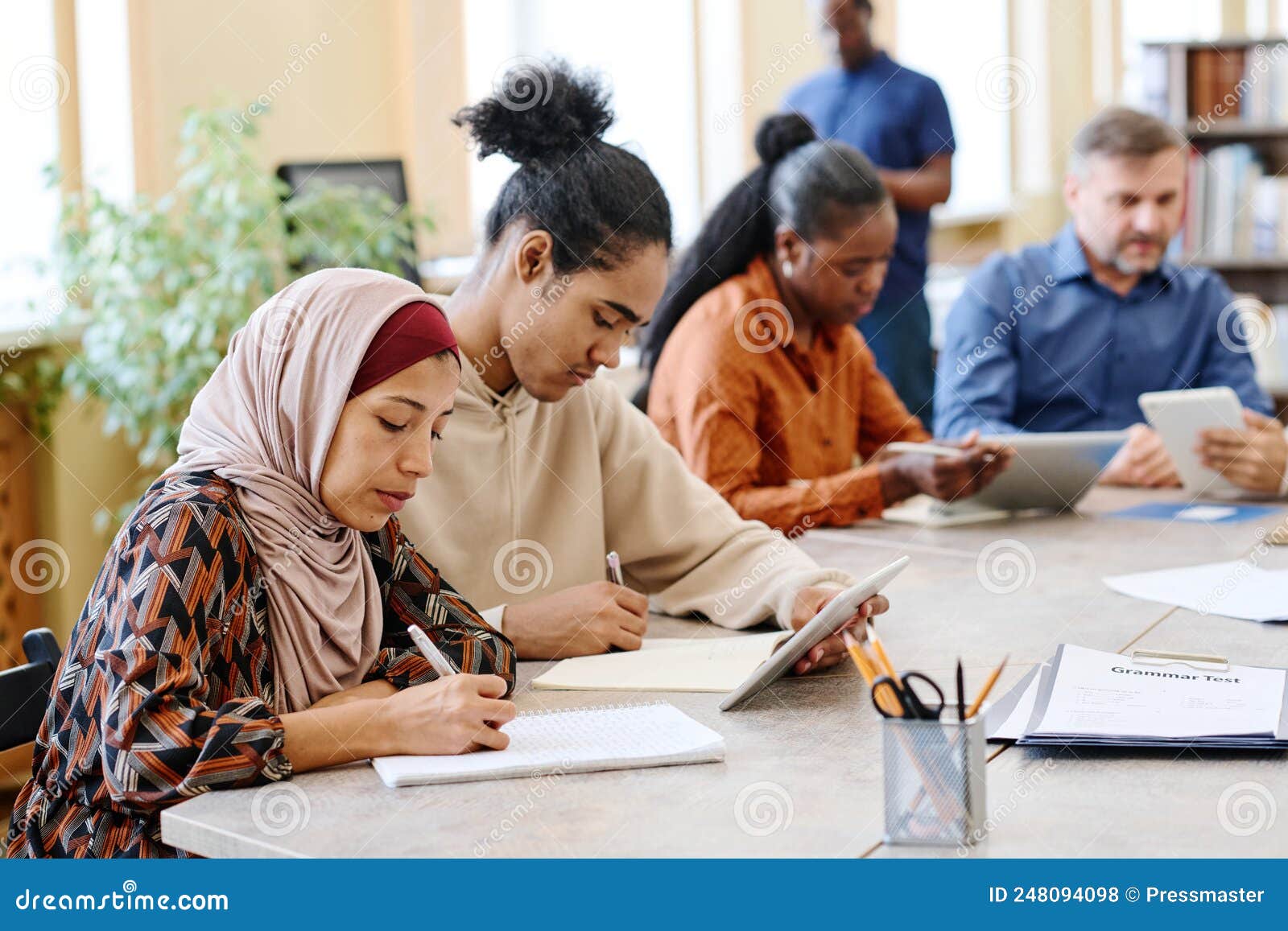 Migrant Students Doing Writing Task Stock Photo - Image of integration ...