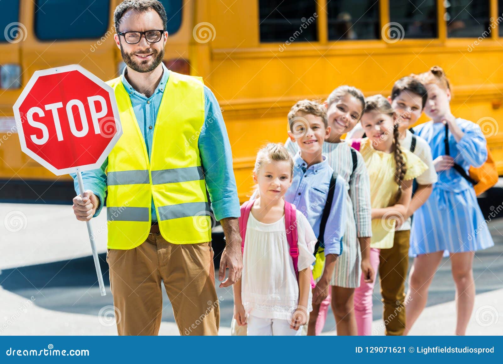 Miling Traffic Guard with Scholars Looking at Camera in Front of Stock ...