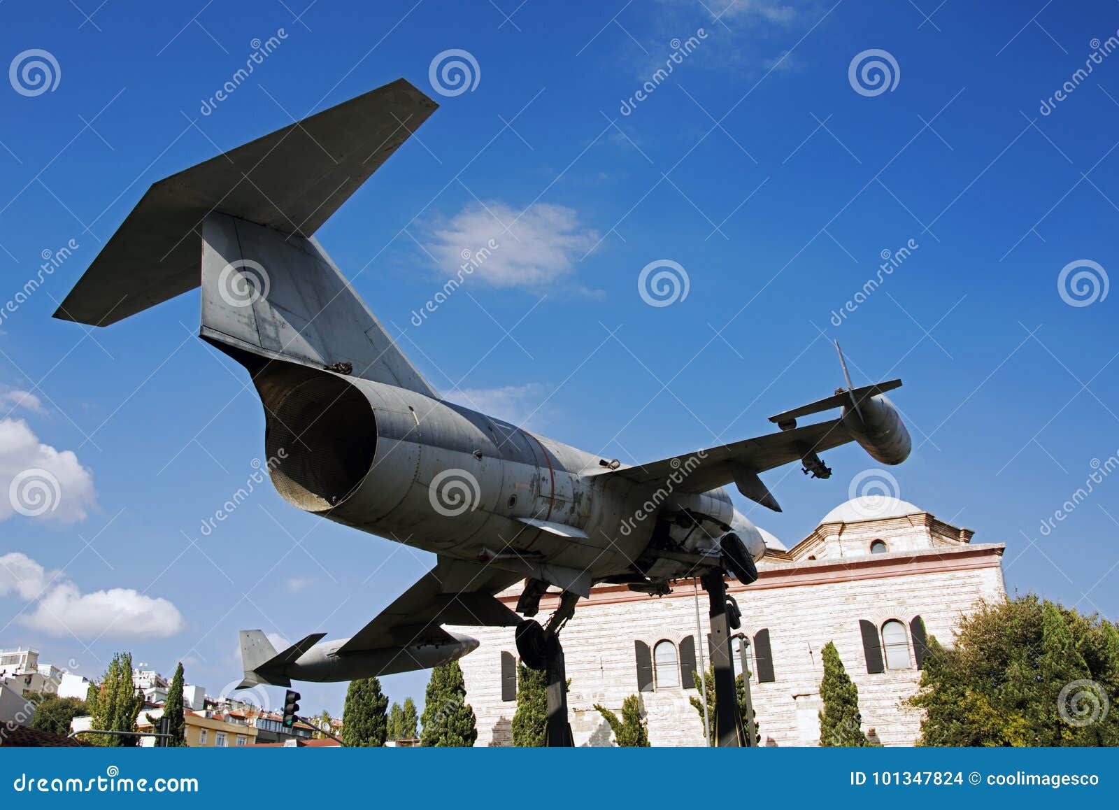 A Military Jet Fighter Flying Over a Building Stock Photo - Image of ...
