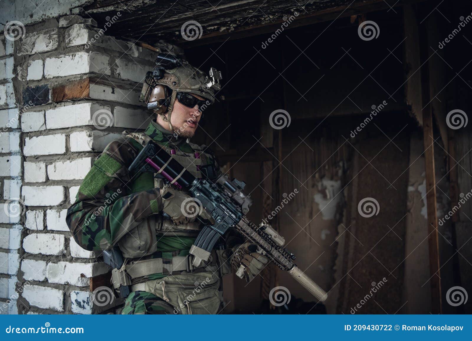 Military Man with Assault Rifle Standing Inside Building, he is Ready ...