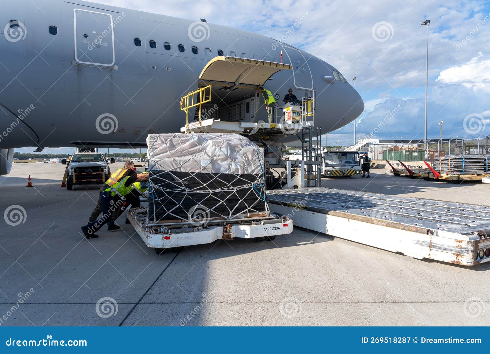Military Plane Getting Loaded with Cargo by Workers Editorial ...