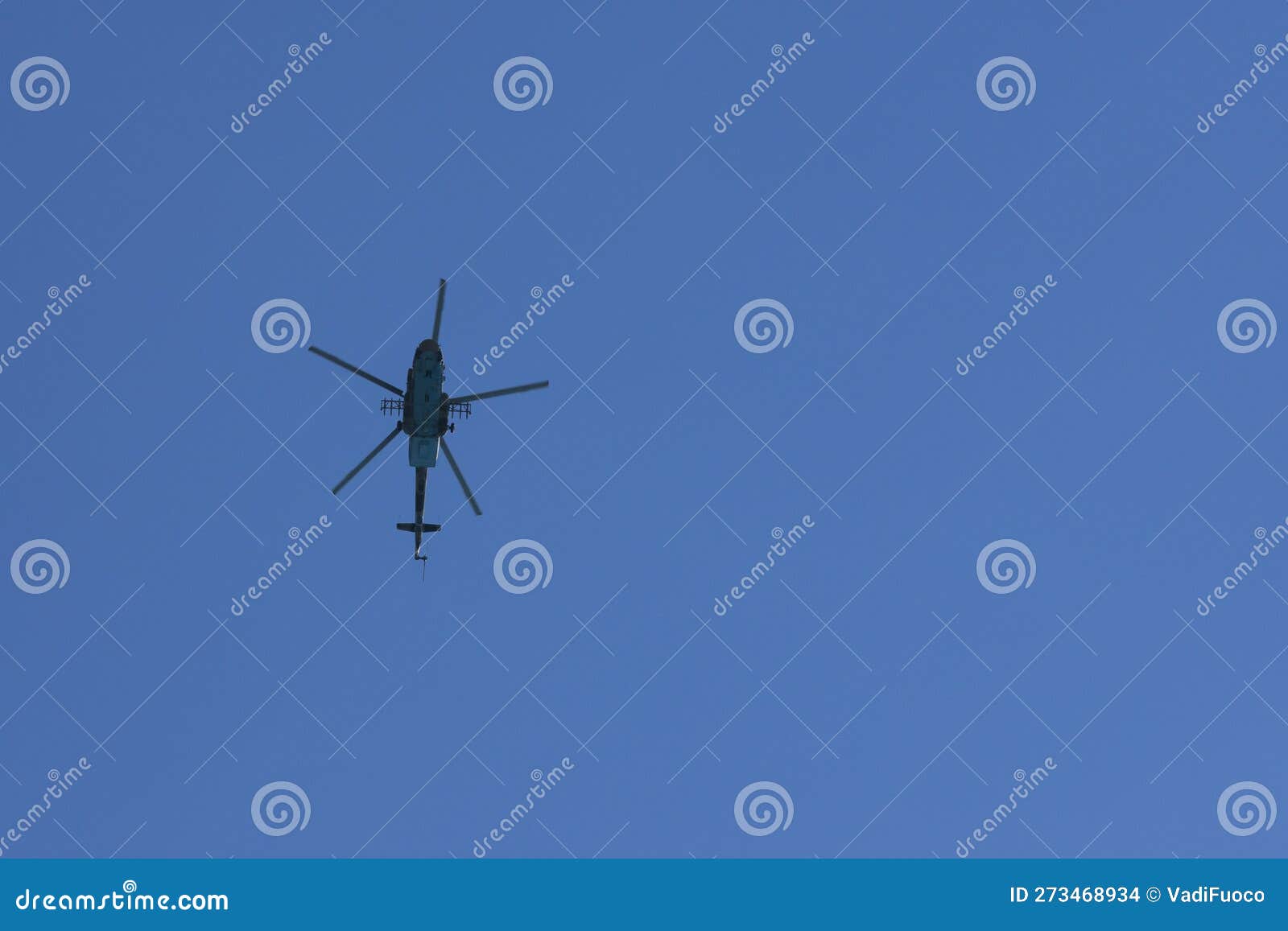 Military Russian Helicopter Flies in the Blue Sky. Bottom View Stock ...