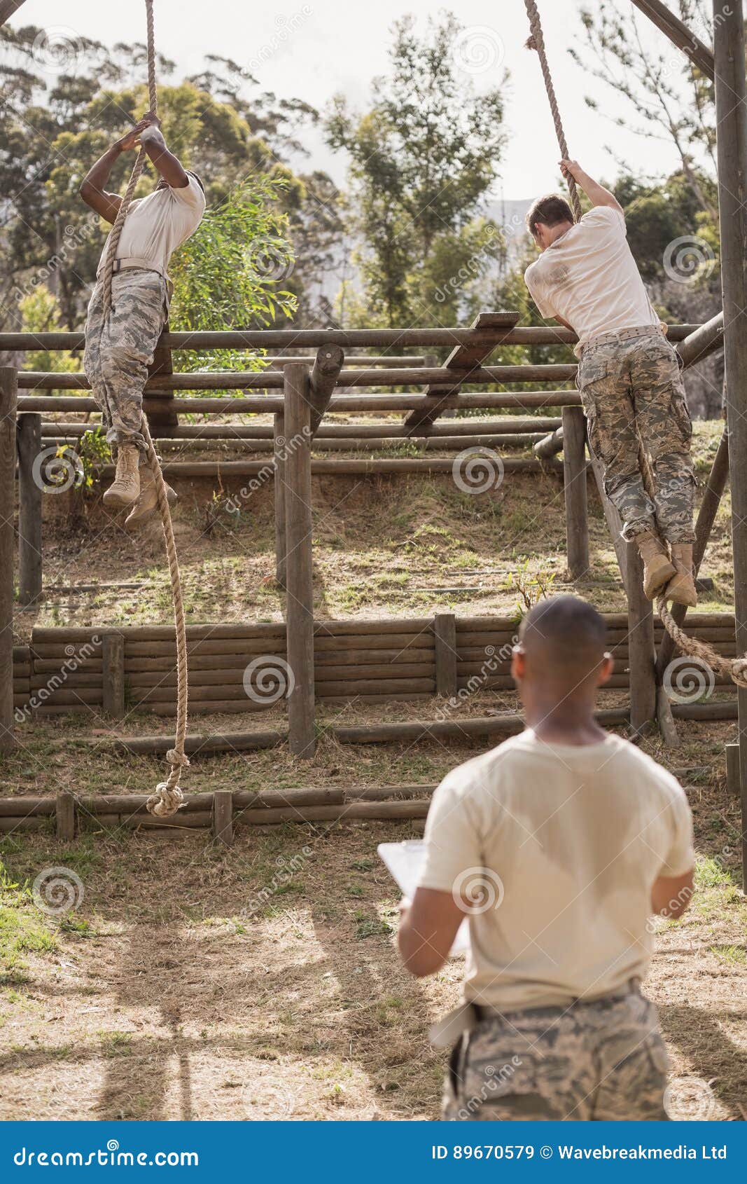 Military Soldiers Climbing Rope during Obstacle Course Training Stock ...