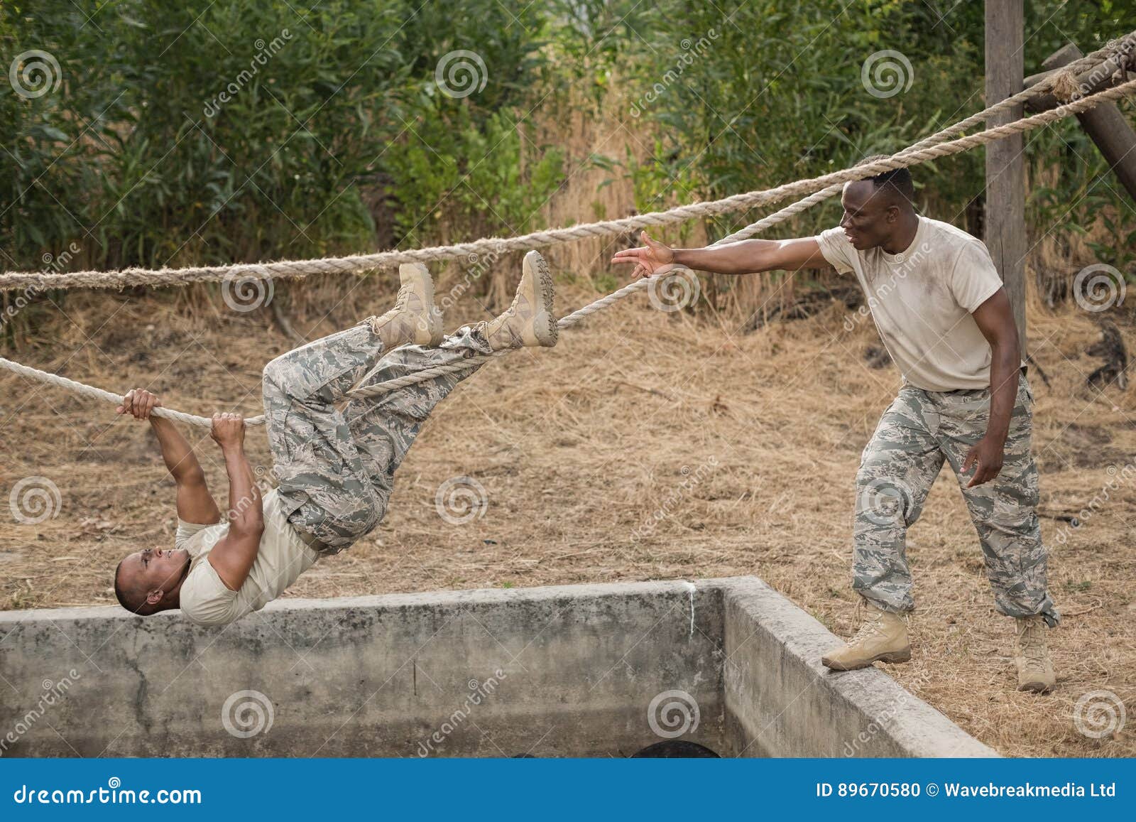 Military Soldiers Climbing Rope during Obstacle Course Training Stock ...