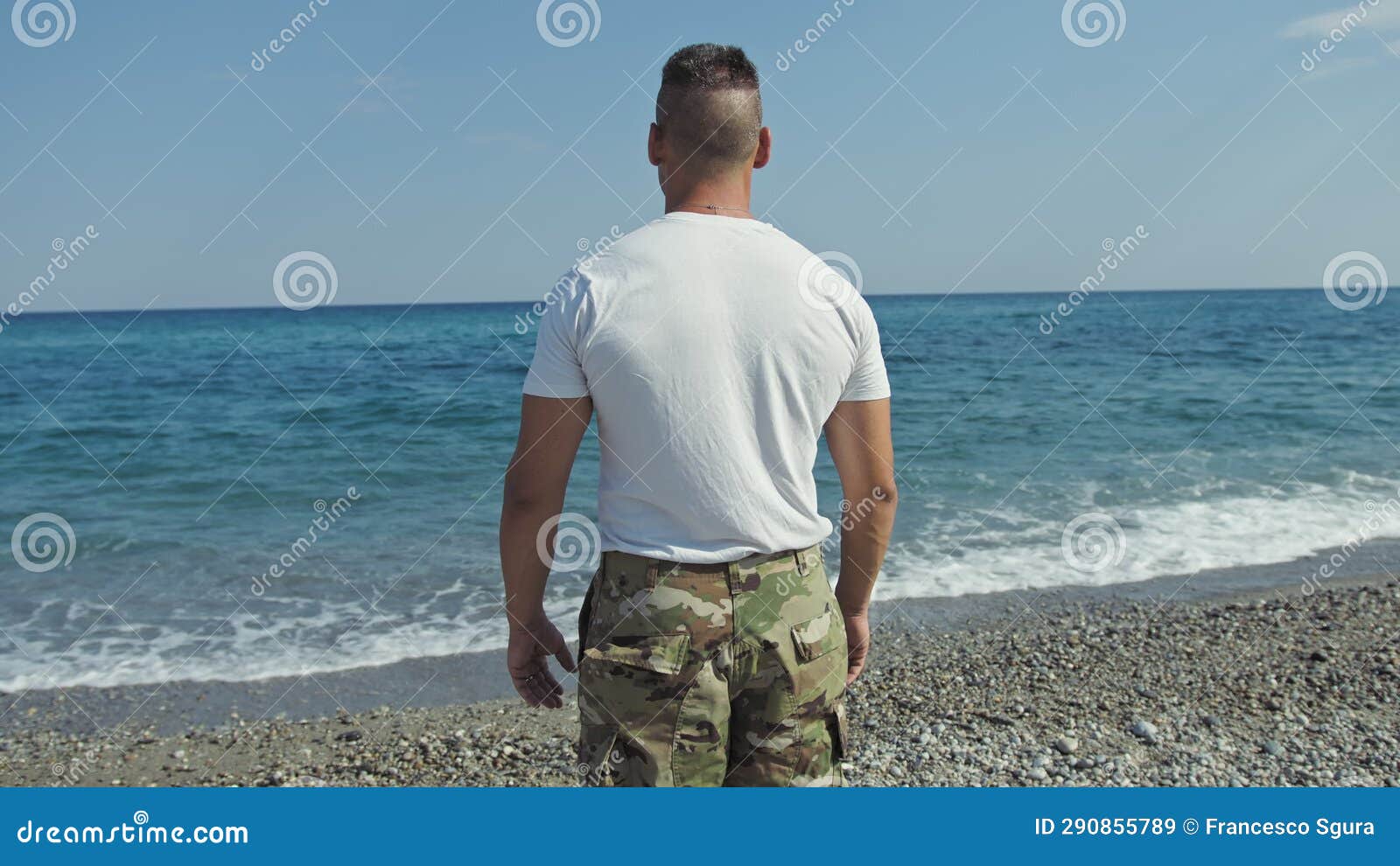 Soldier looks at the ocean stock video. Video of survival - 290855789