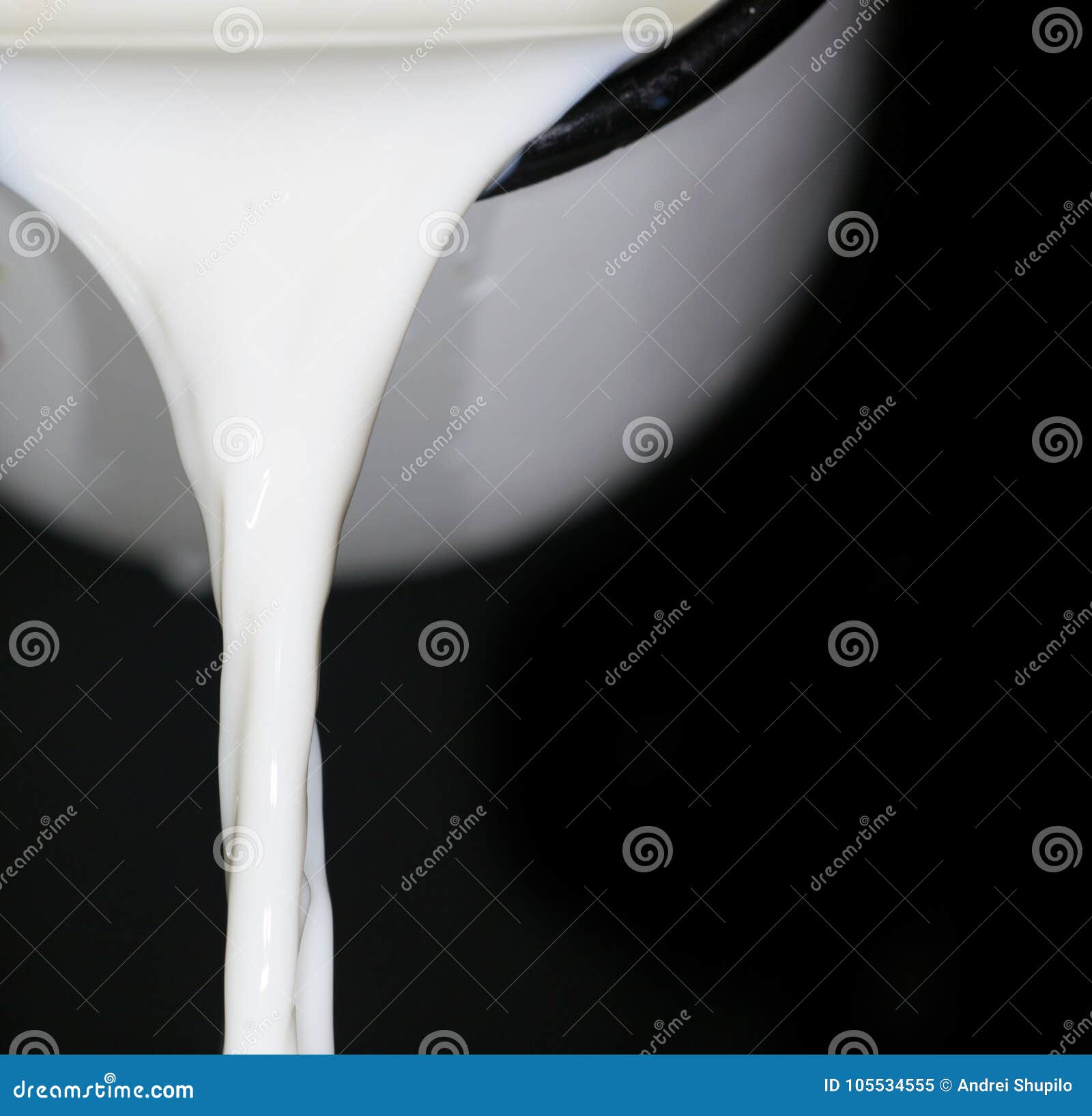 Milk on a black background stock image. Image of flowing - 105534555