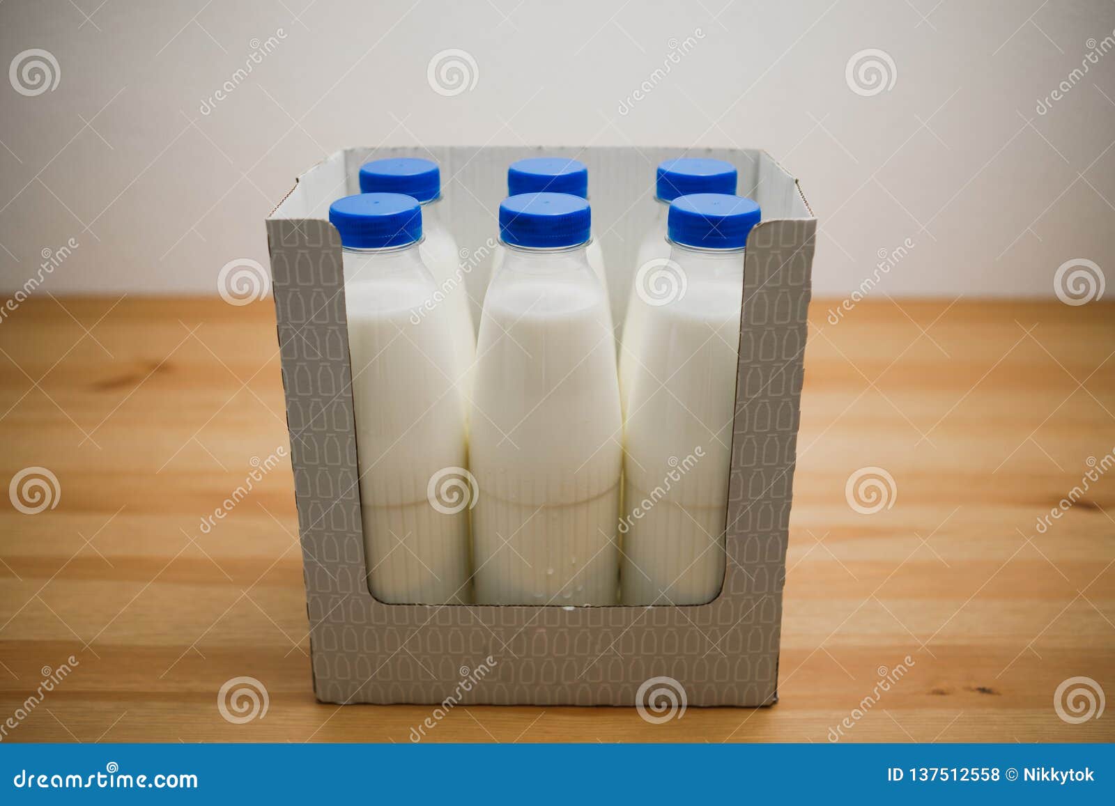 Milk Bottles in Cardboard Box on Wooden Table Stock Photo - Image of ...