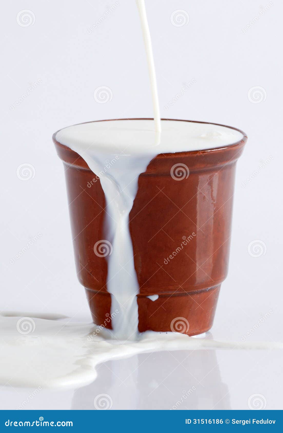 Milk Poured from a Clay Cup Stock Photo - Image of isolated, milk: 31516186