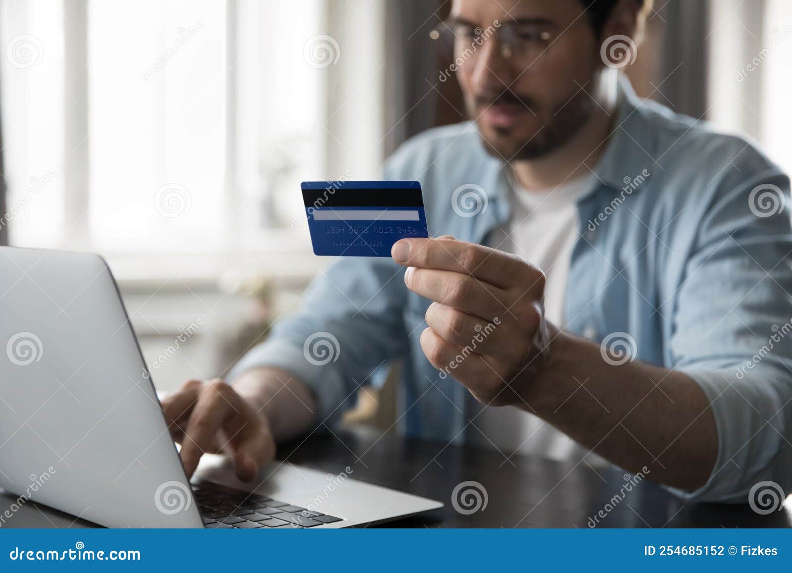 Millennial Man Using Computer, Holding Credit Card at Camera Stock ...