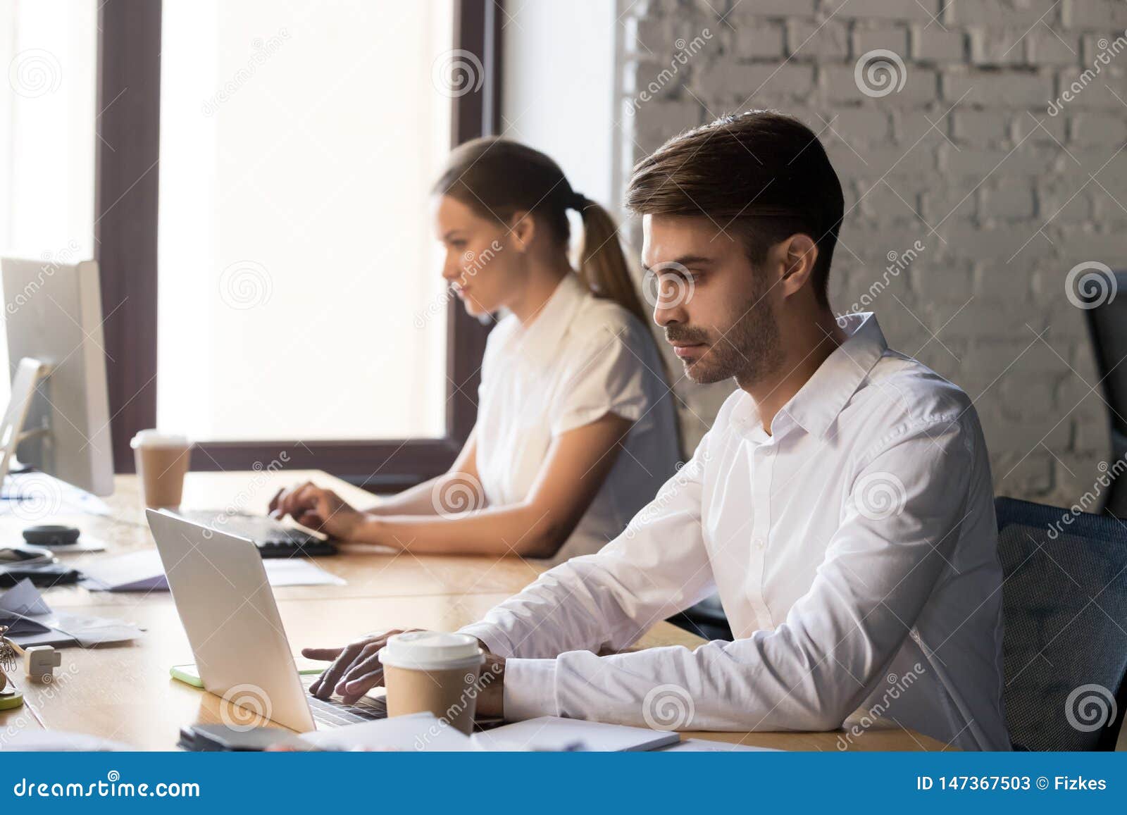 Millennial Office Worker Typing on Computer Working at Shared Office ...