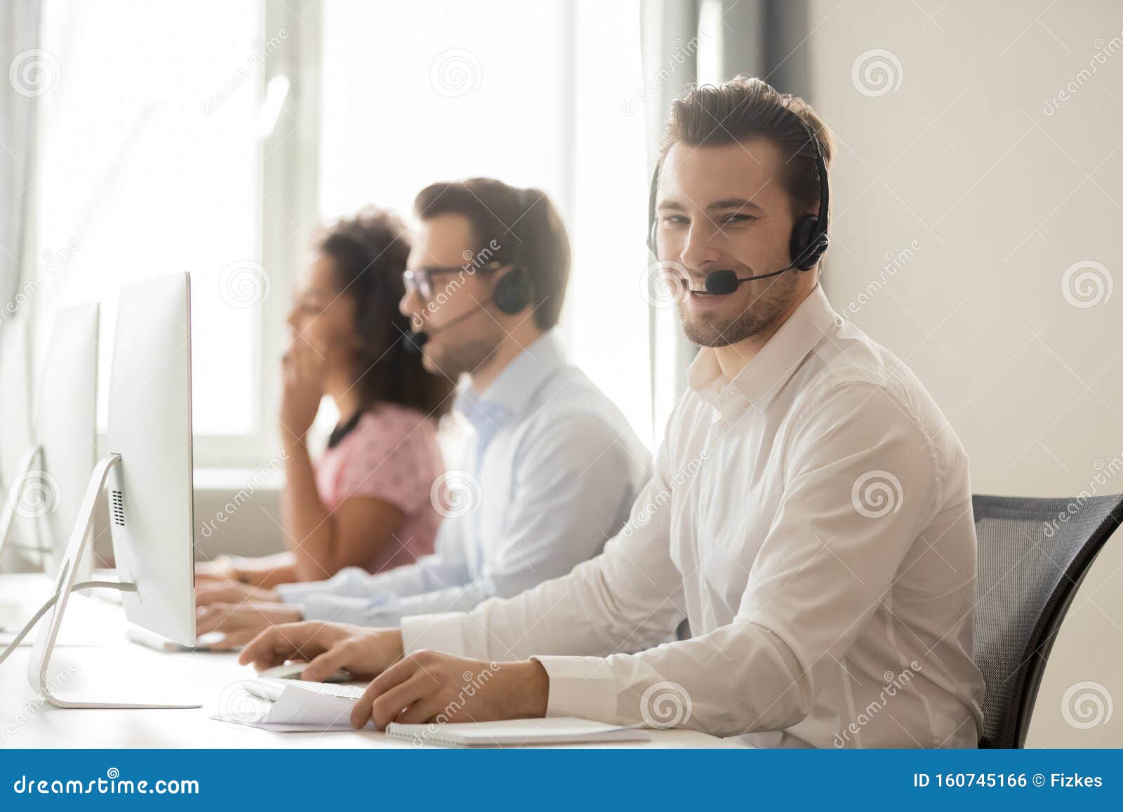Millennial Service Phone Operator Sitting at Workplace Pose for Camera ...