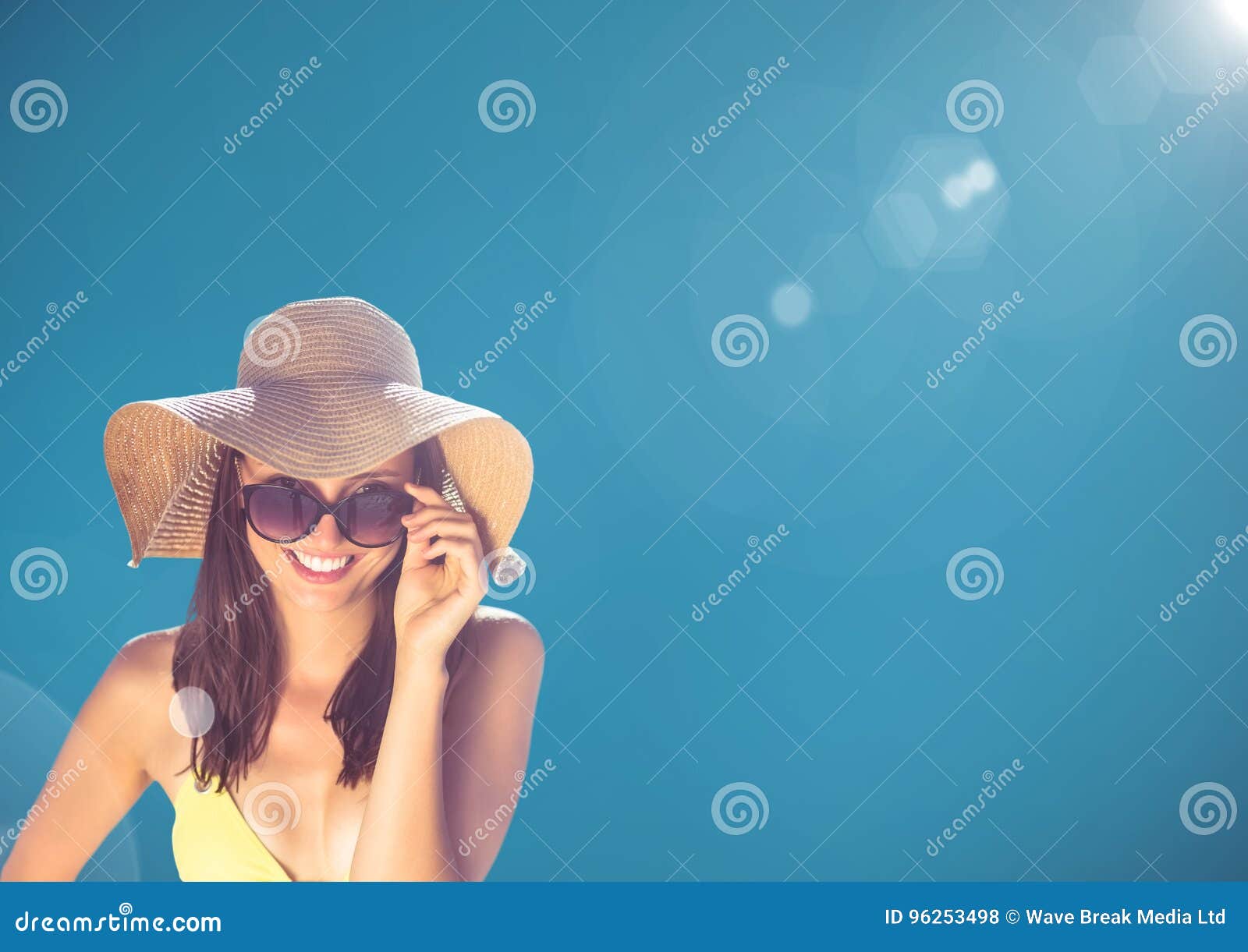Millennial Woman Looking Through Sunglasses Against Blue Background And