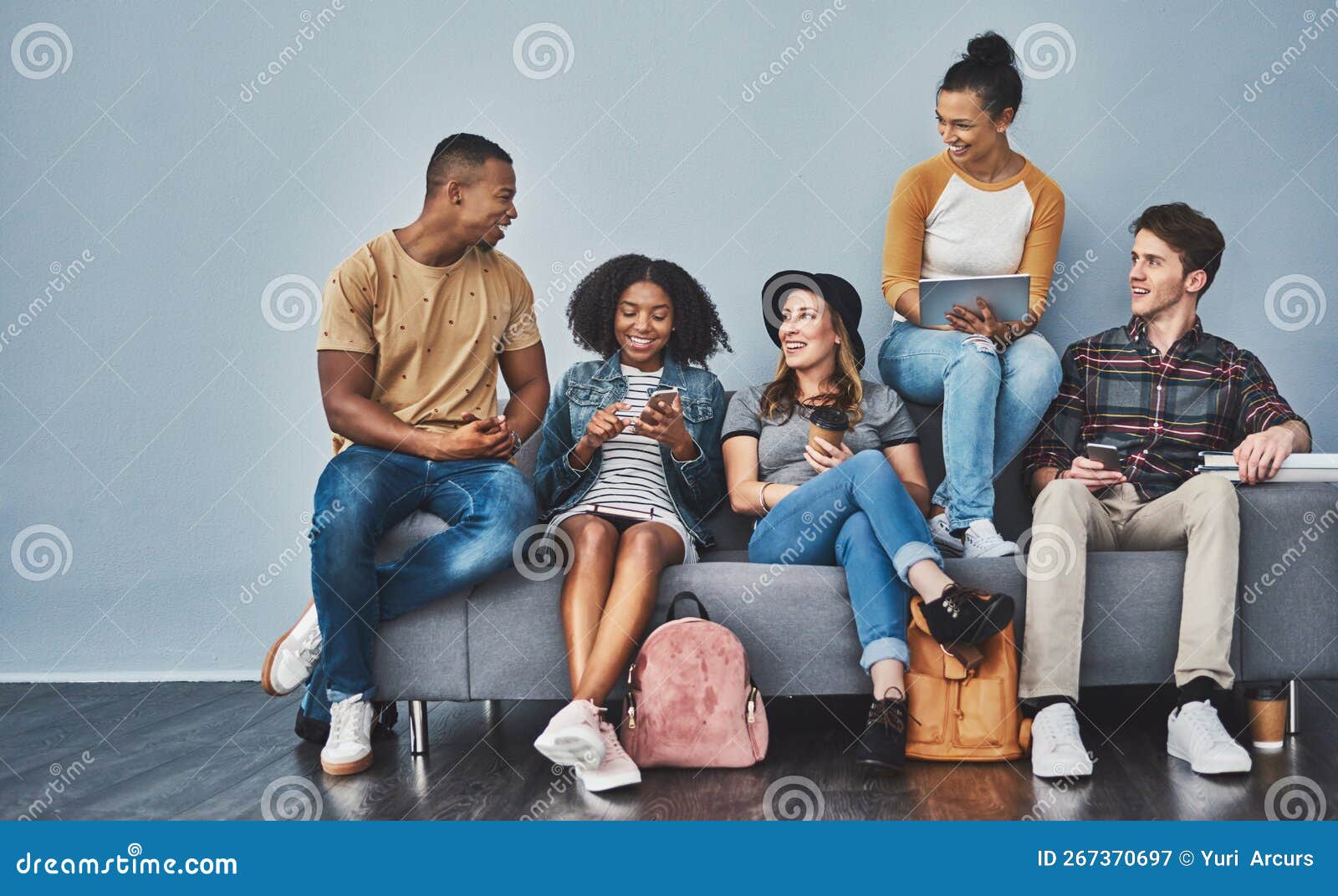 Millennials Aka Social Media Experts. Studio Shot of Young People Sitting on a Sofa and Using ...