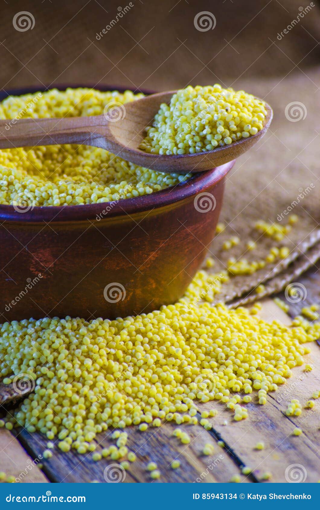 Millet in a bowl stock photo. Image of yellow, wood, millet - 85943134