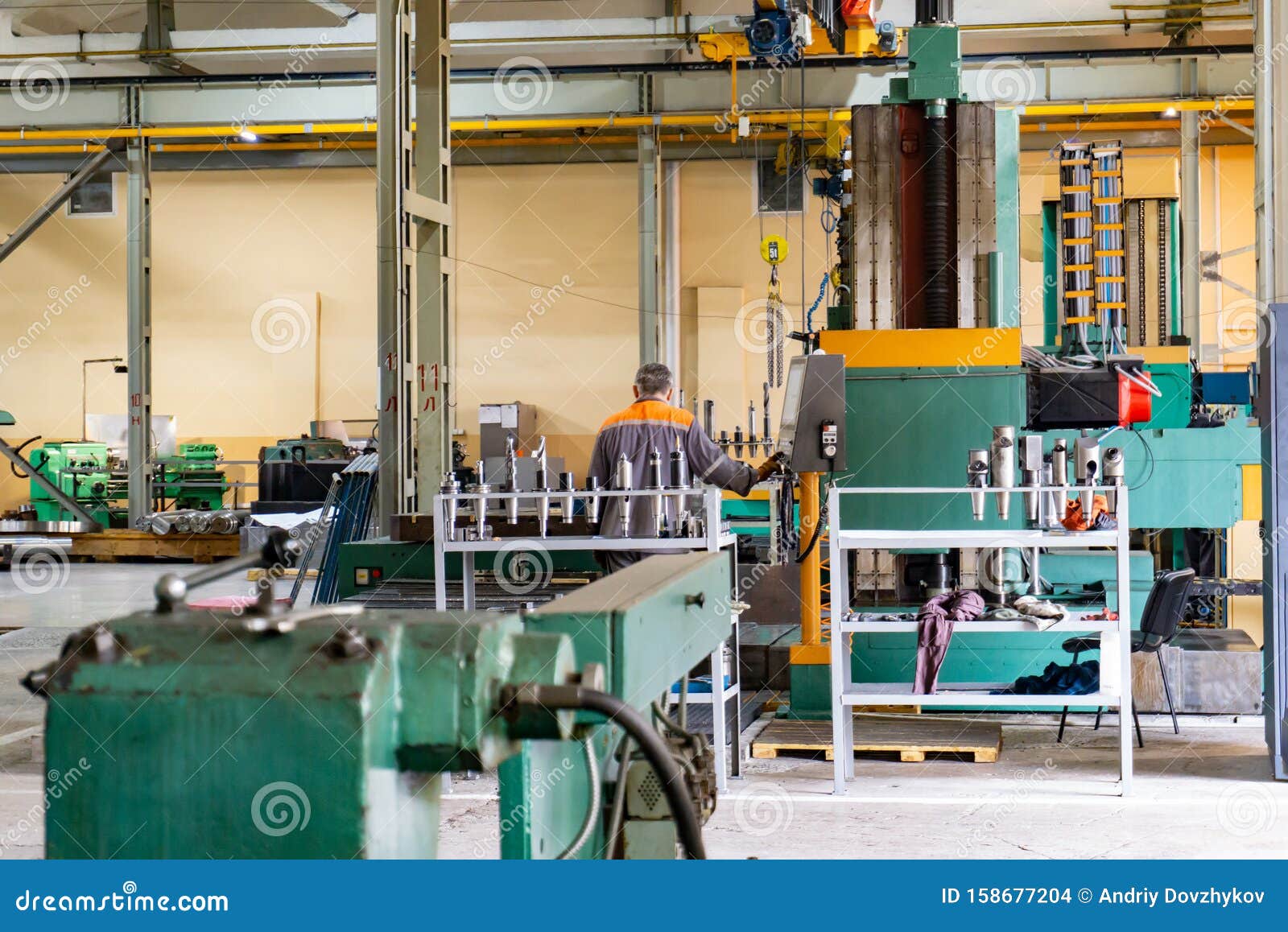 A Milling Machine Operator Behind a Cnc Machine Exposes a Part for ...