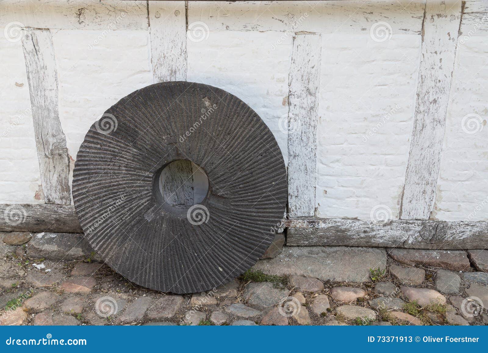 Millstone Standing on a Wall Stock Image - Image of ancient, plant ...