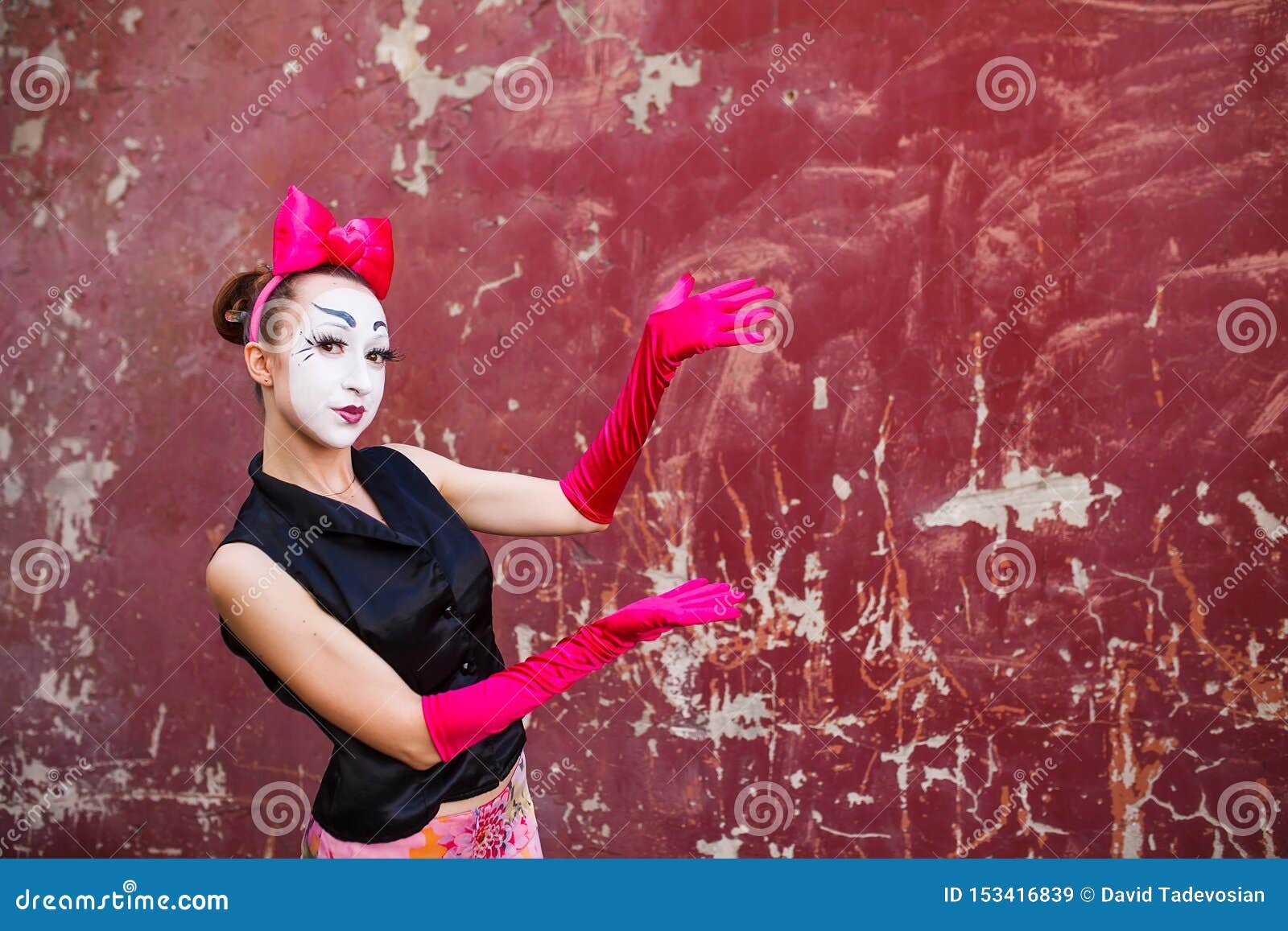 Mime Points a Finger at the Center Against a Background of a Red Wall ...