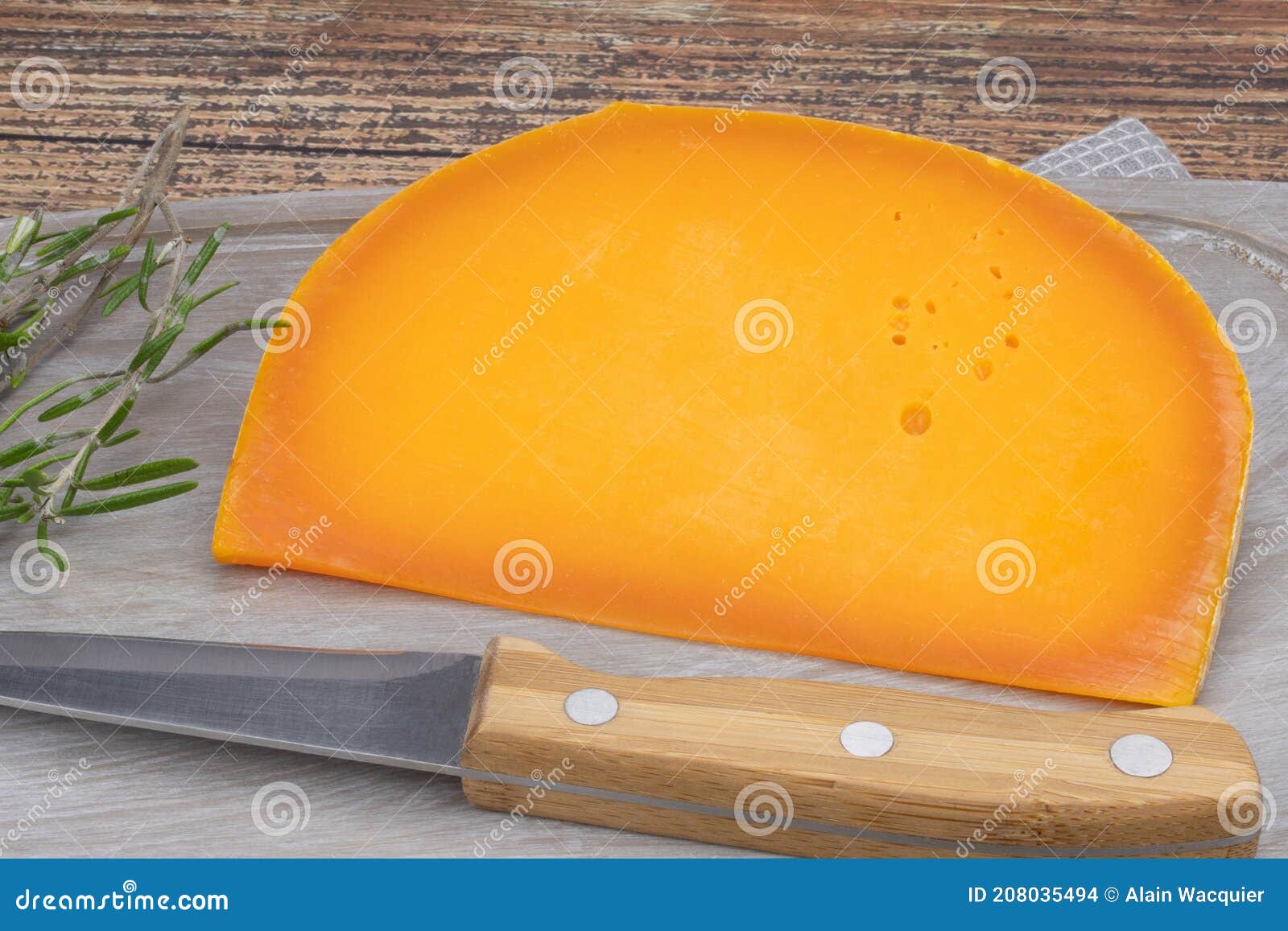 Mimolette Cheese on a Cutting Board Stock Photo - Image of wooden ...