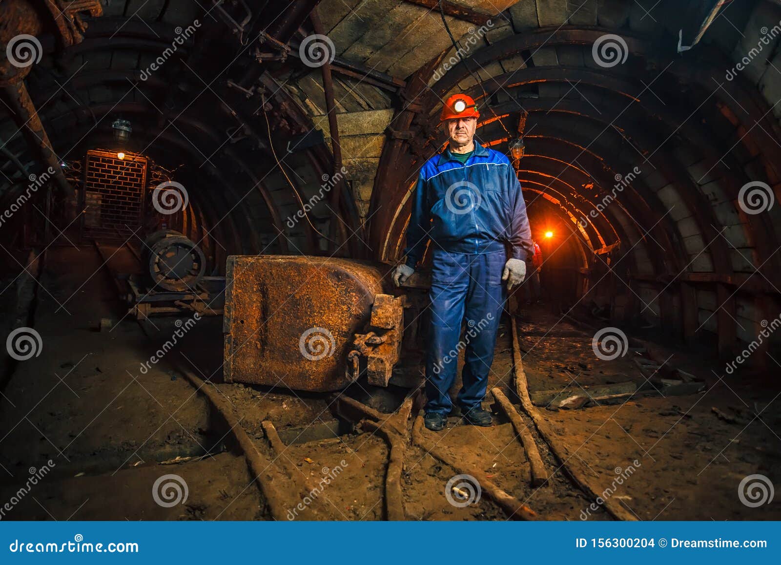 A Miner in a Coal Mine Stands Near a Trolley. Copy Space. Stock Photo ...
